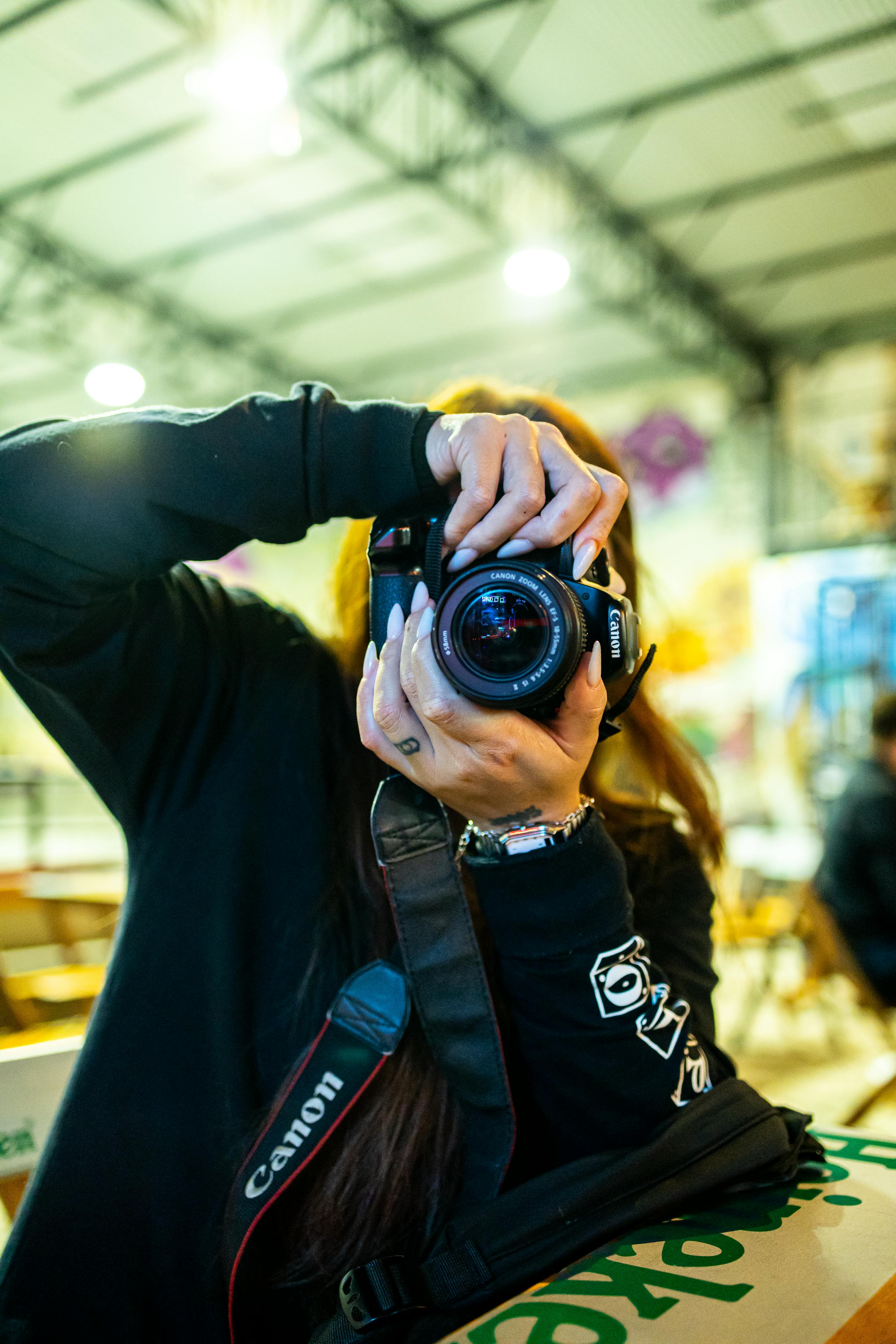 Female Photographer Capturing Indoor Scenes · Free Stock Photo