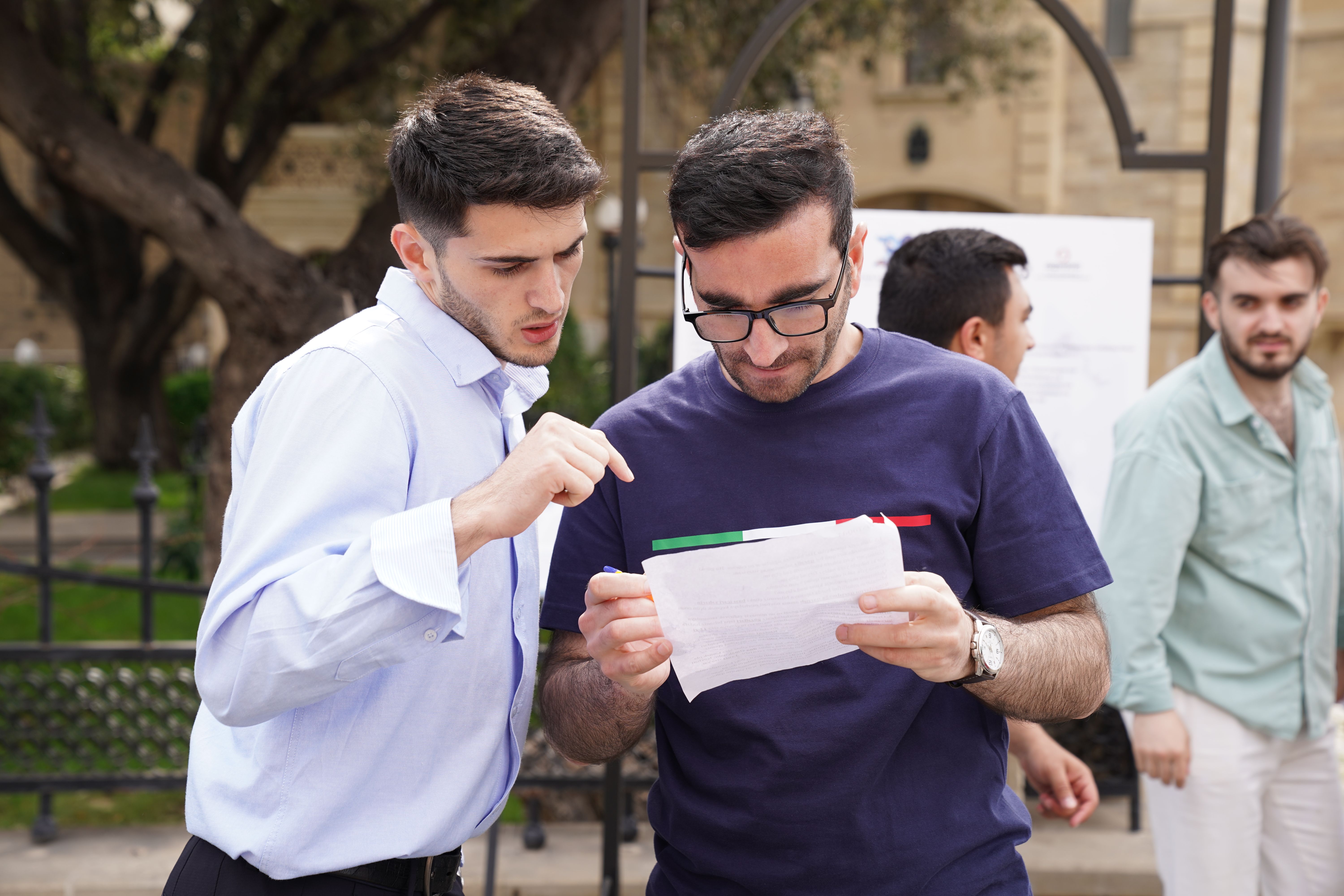 Young Professionals Discuss Plans Outdoors · Free Stock Photo