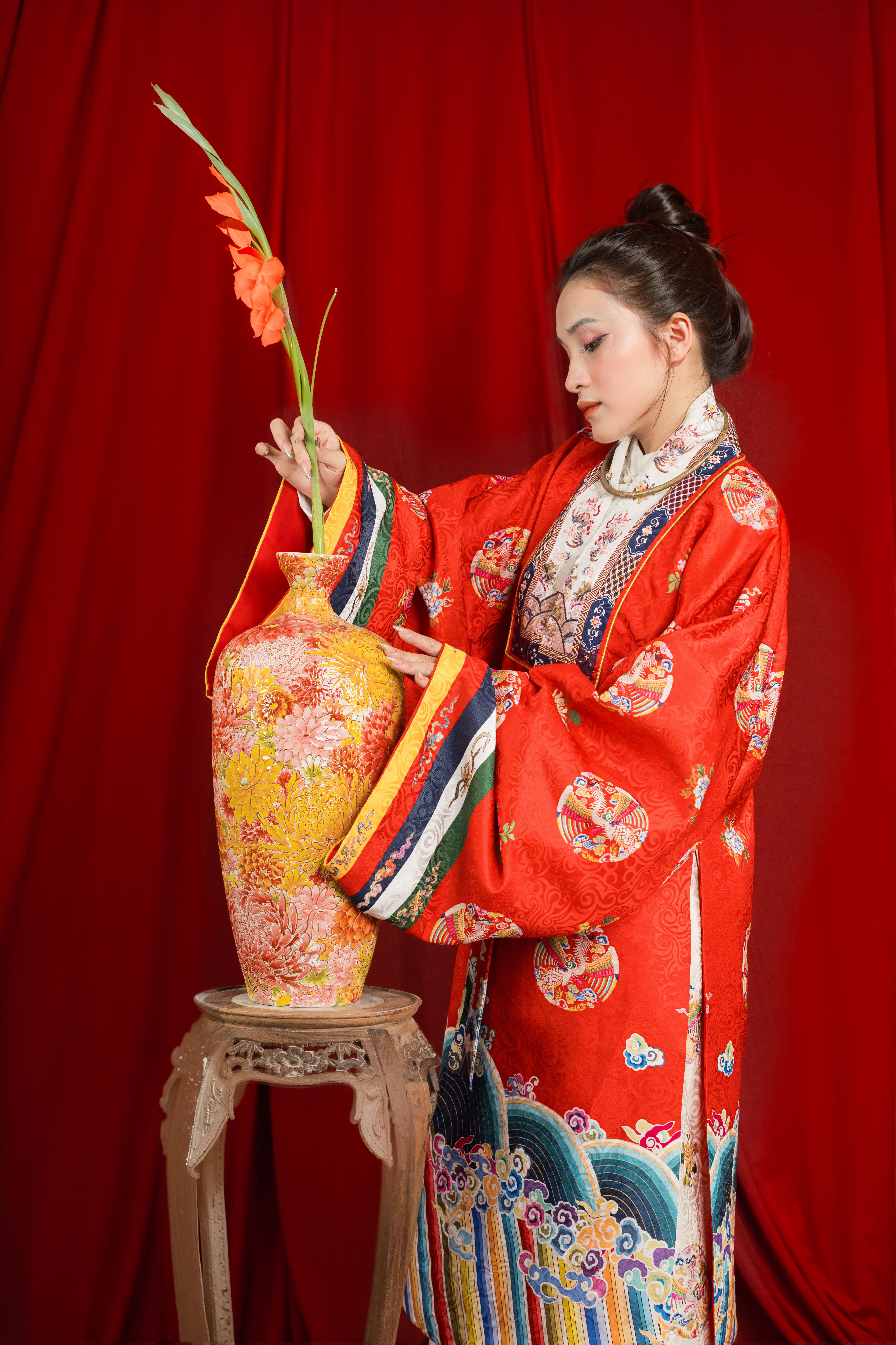 Elegant Traditional Asian Attire with Vase · Free Stock Photo