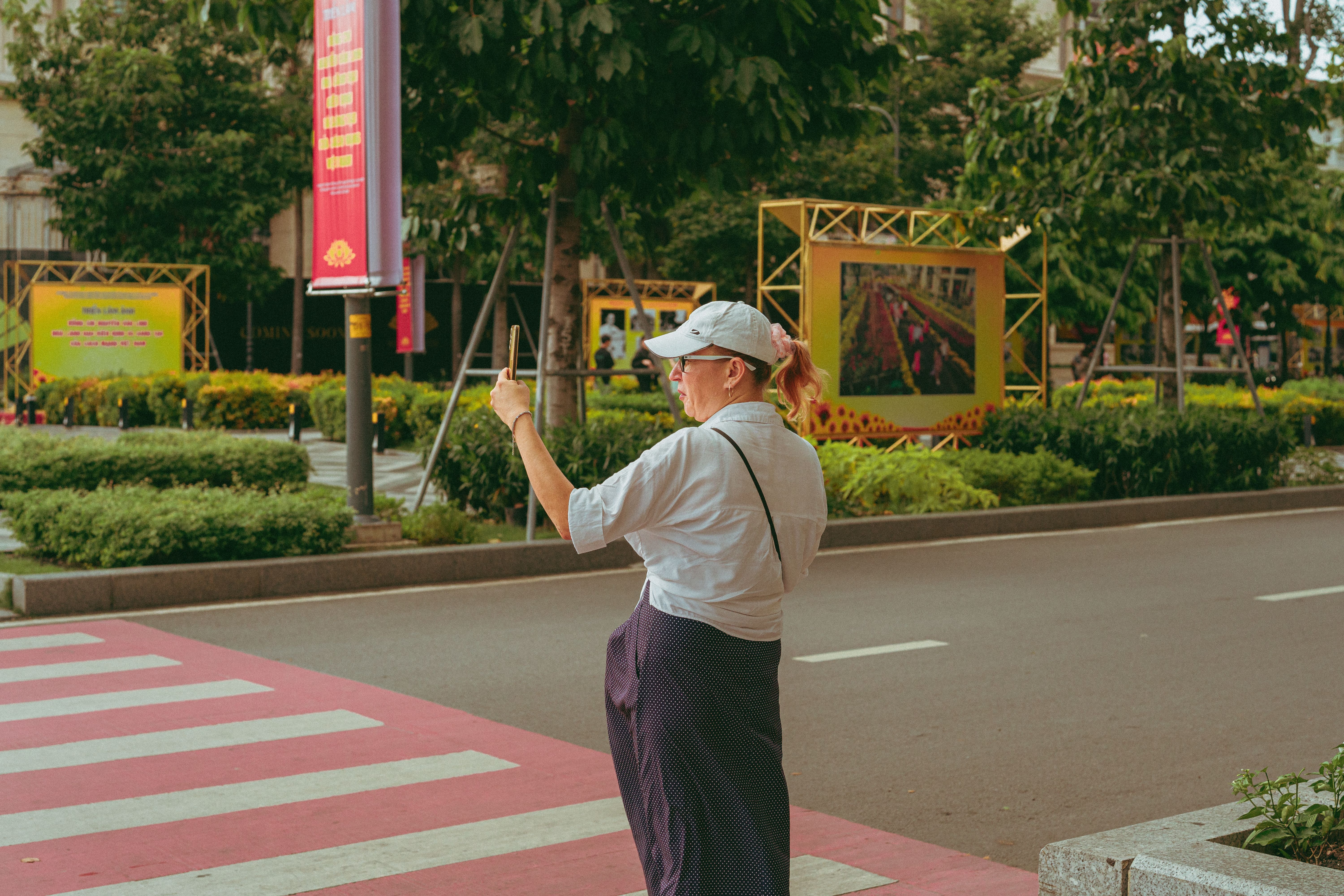 Woman Taking a Photo in Ho Chi Minh City Street · Free Stock Photo