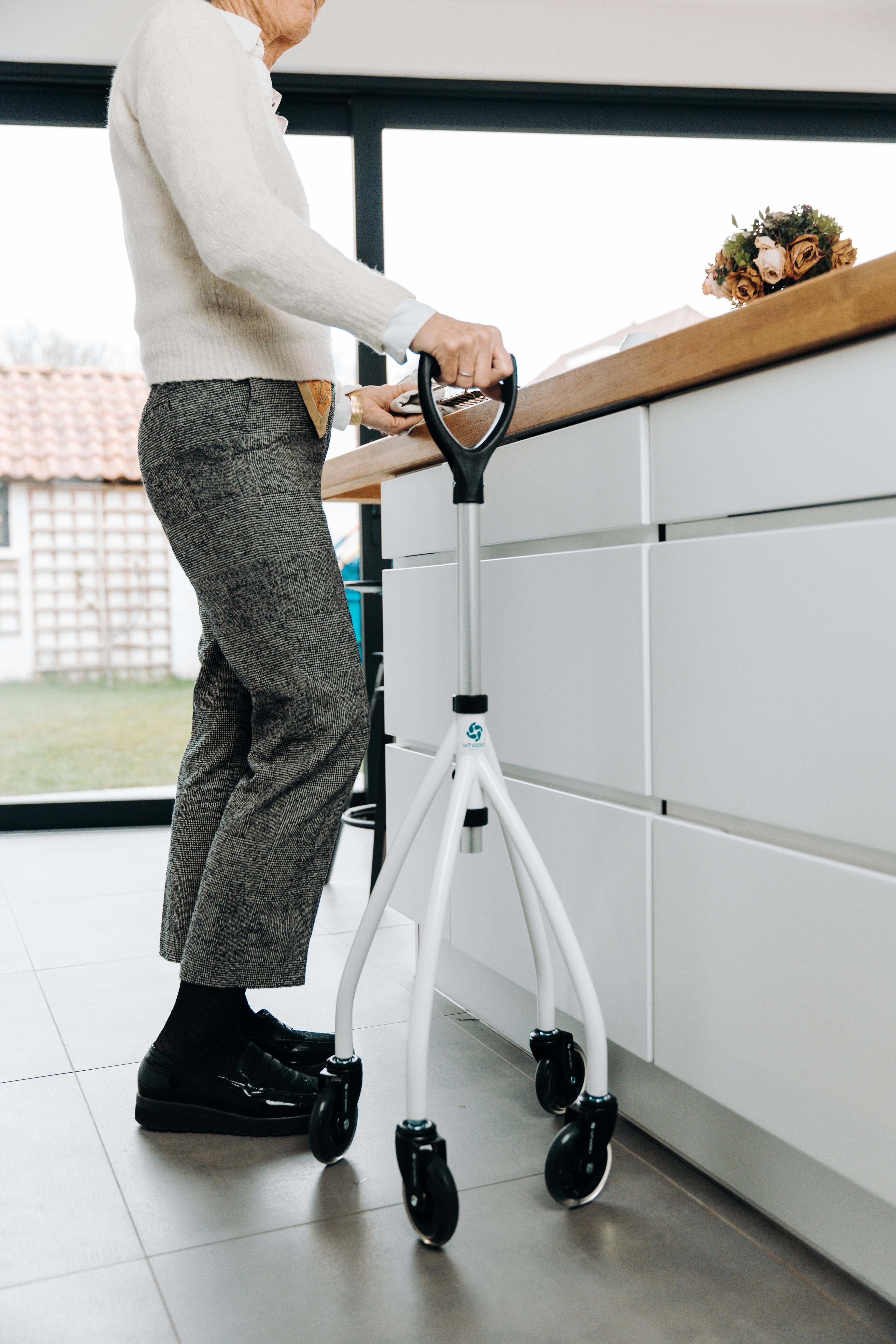 Senior using modern walker in bright kitchen · Free Stock Photo