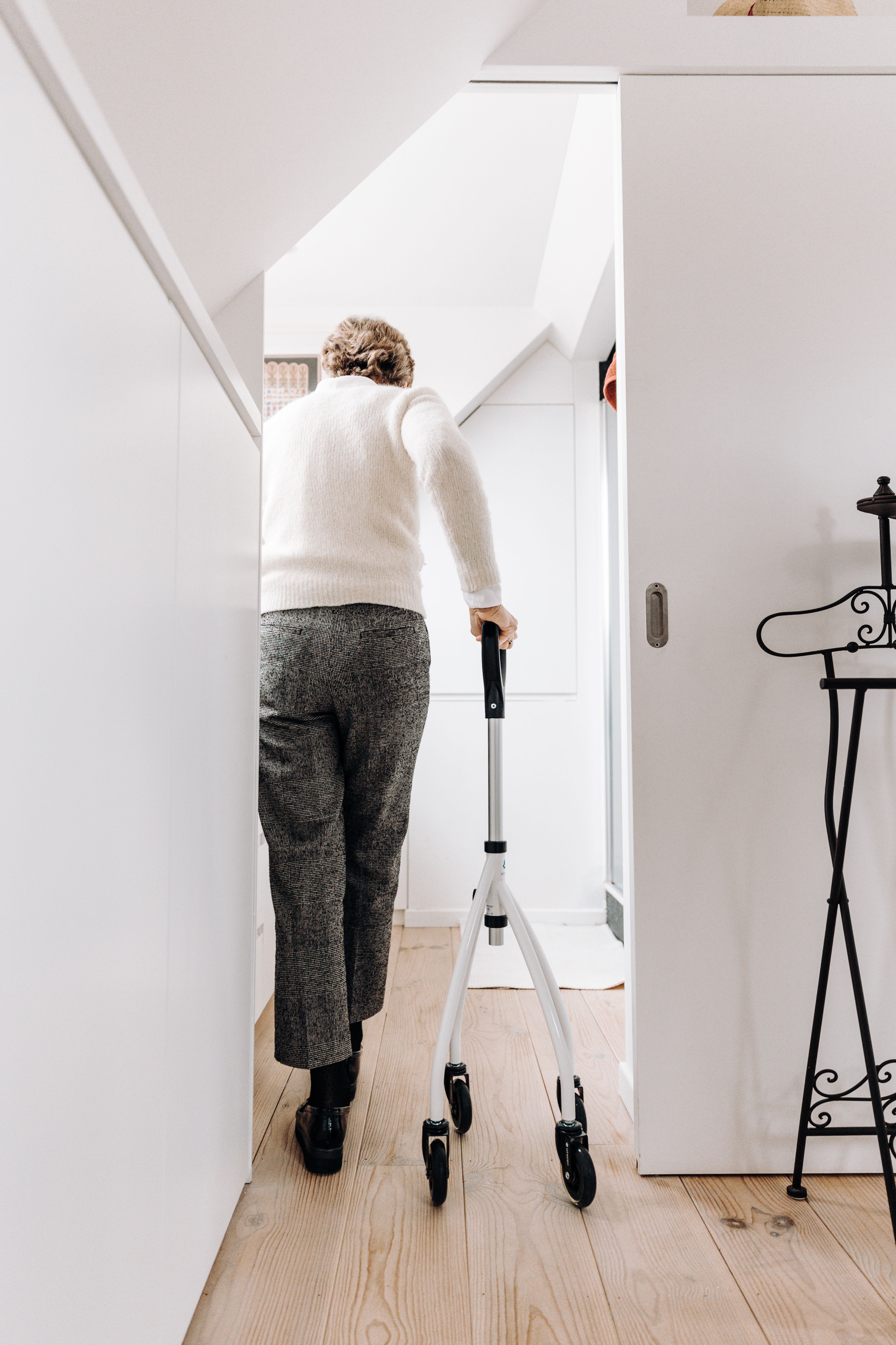 Senior Adult Using Rollator Indoors · Free Stock Photo