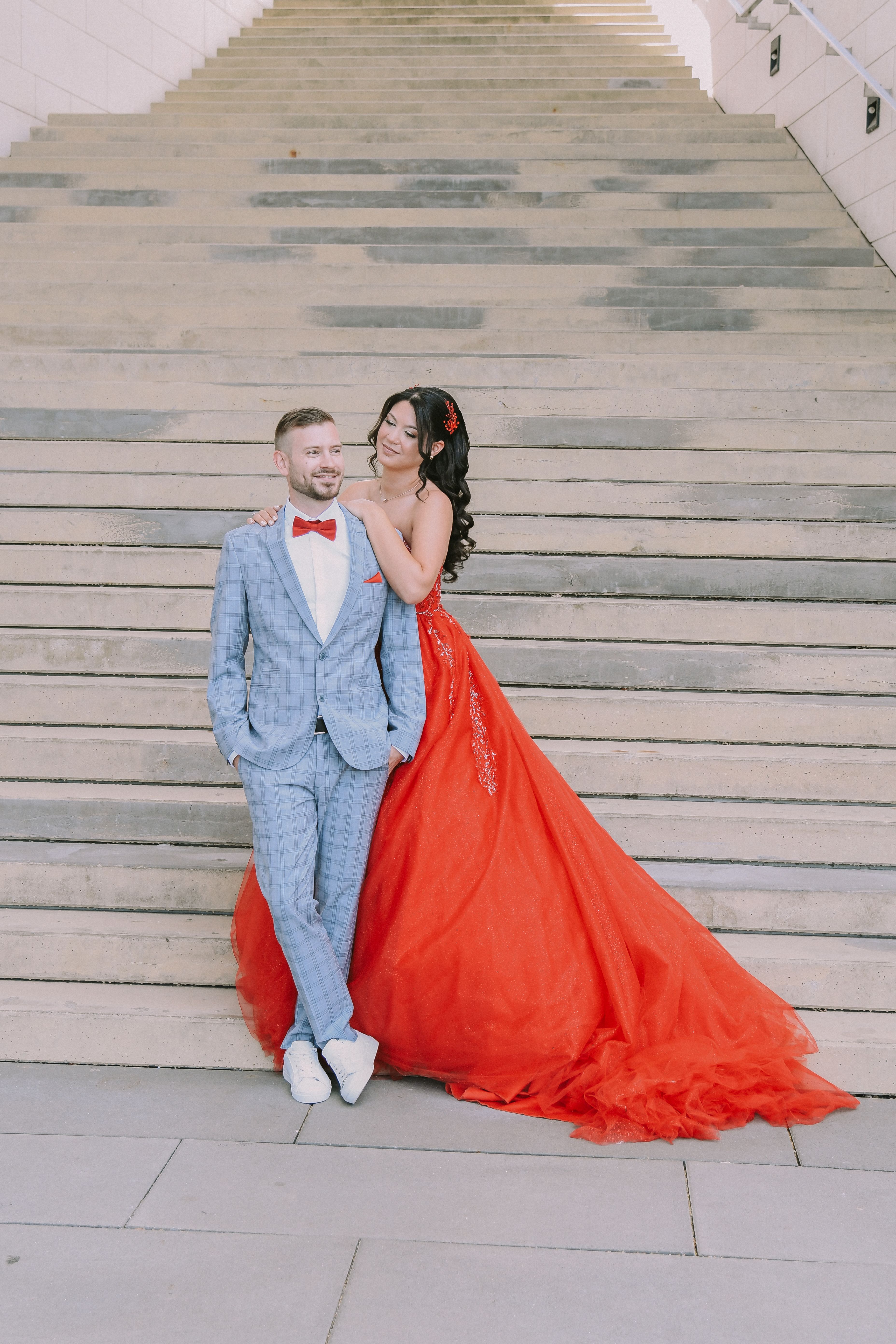 Elegant Couple on Steps in Formal Attire · Free Stock Photo