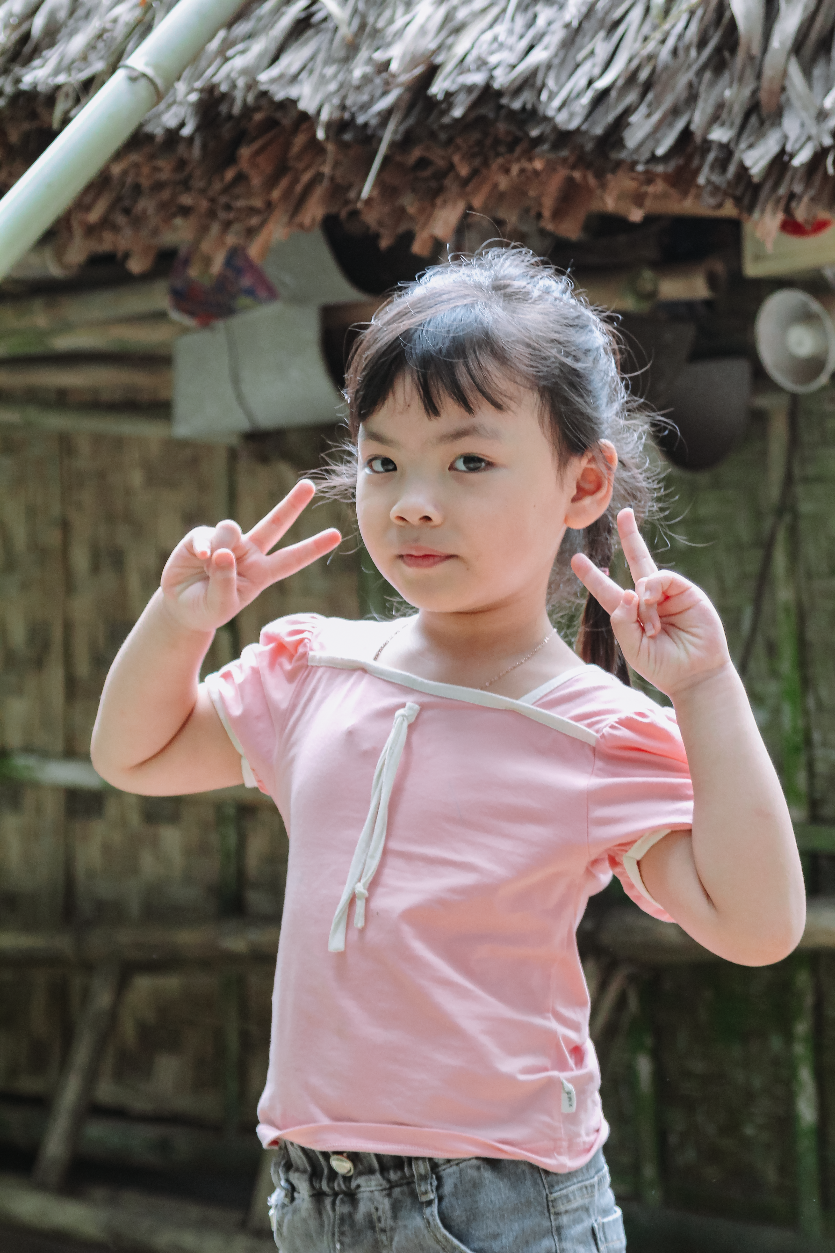 Child Posing with Peace Signs Outdoors · Free Stock Photo