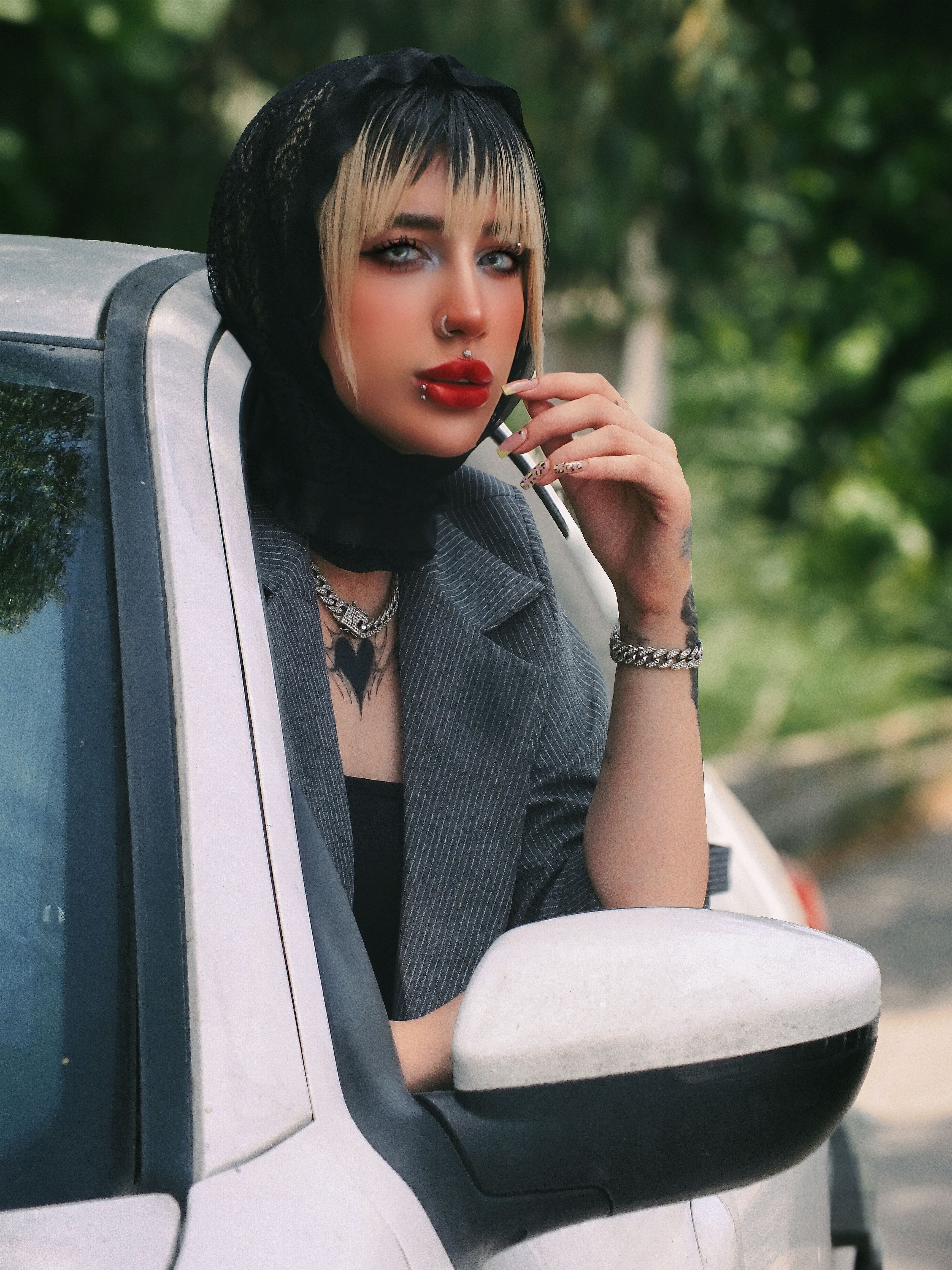 Stylish Woman with Piercings in Car Window · Free Stock Photo