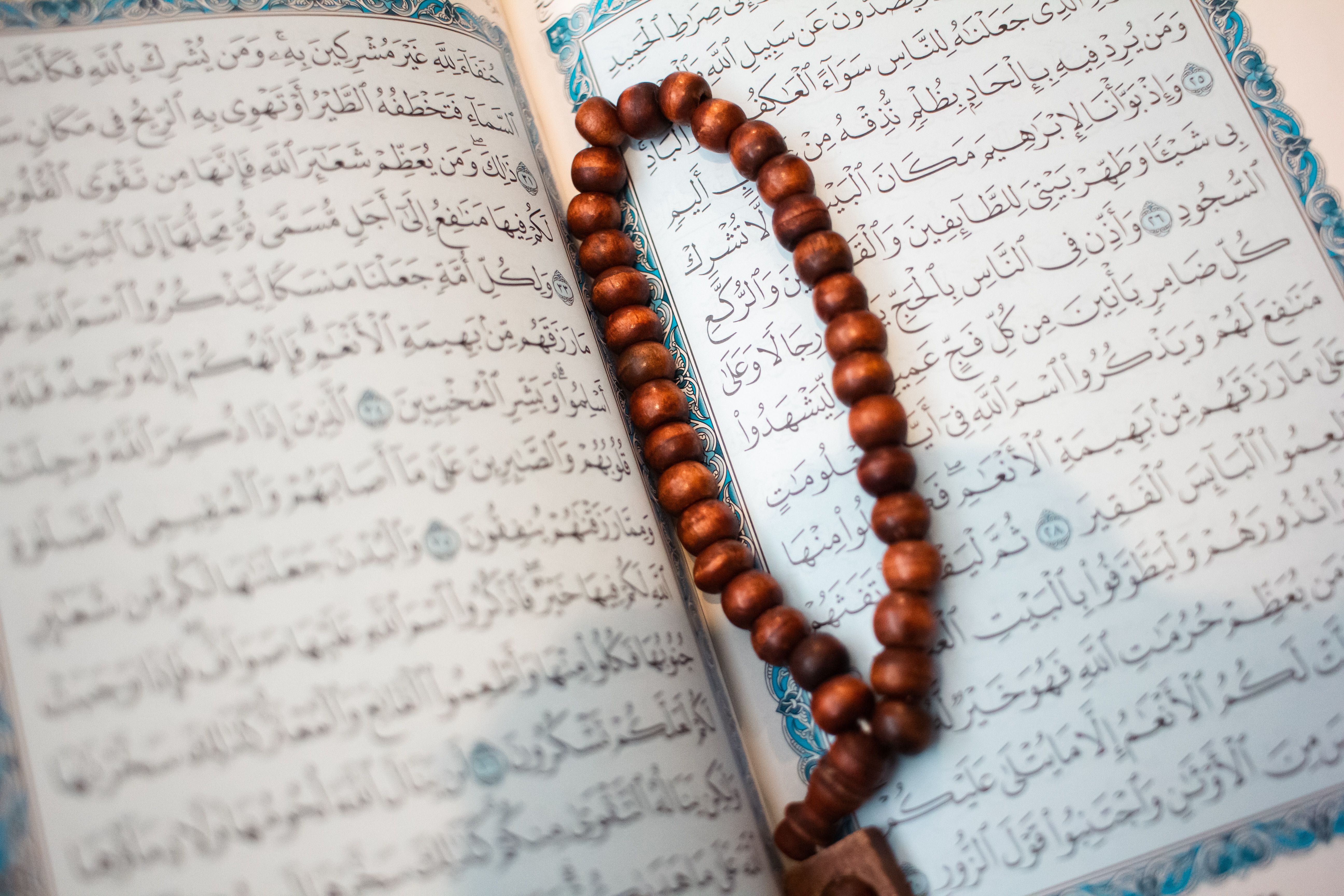 Open Quran with Prayer Beads on Arabic Text · Free Stock Photo