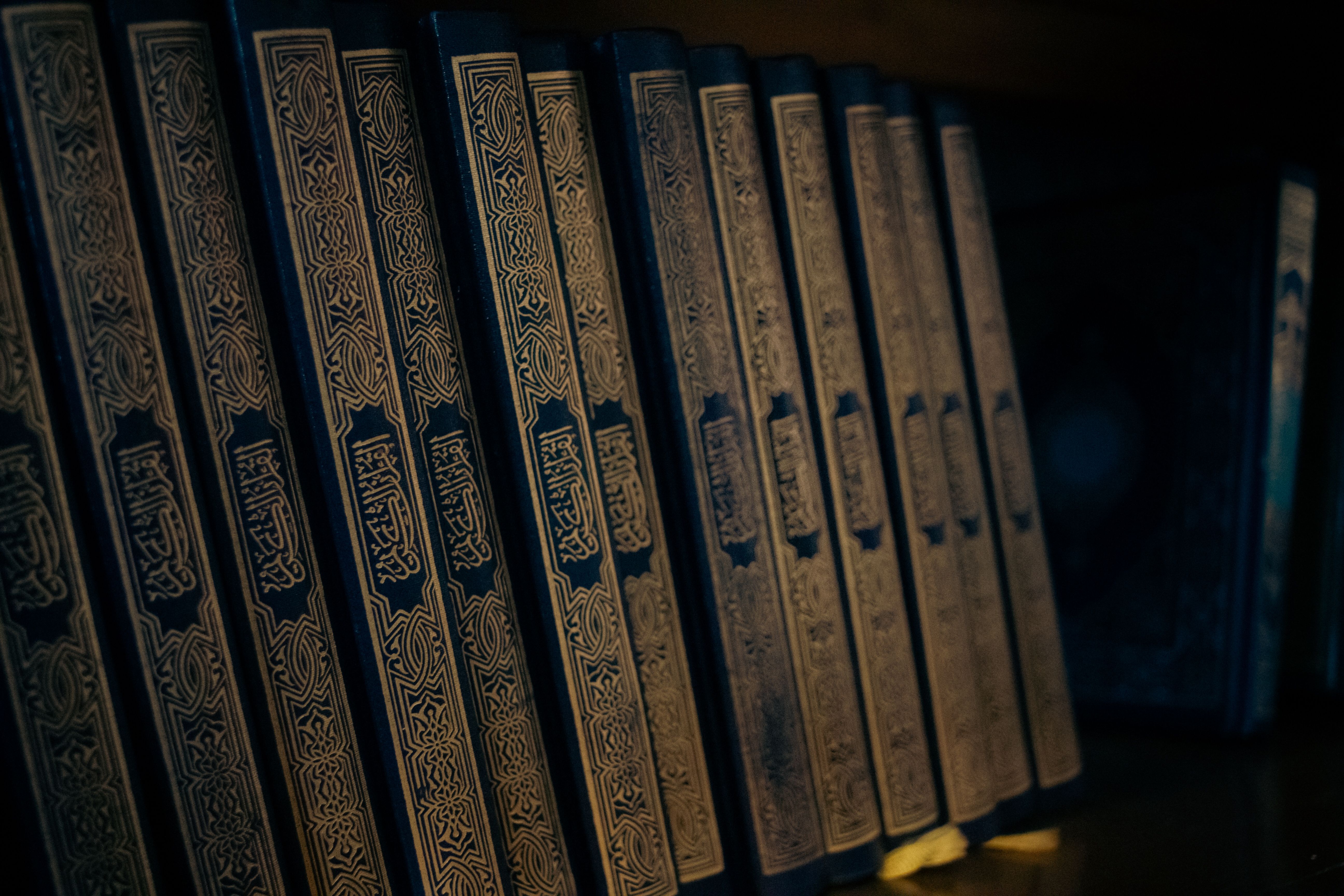 Elegant Arabic Calligraphy on Quran Books · Free Stock Photo