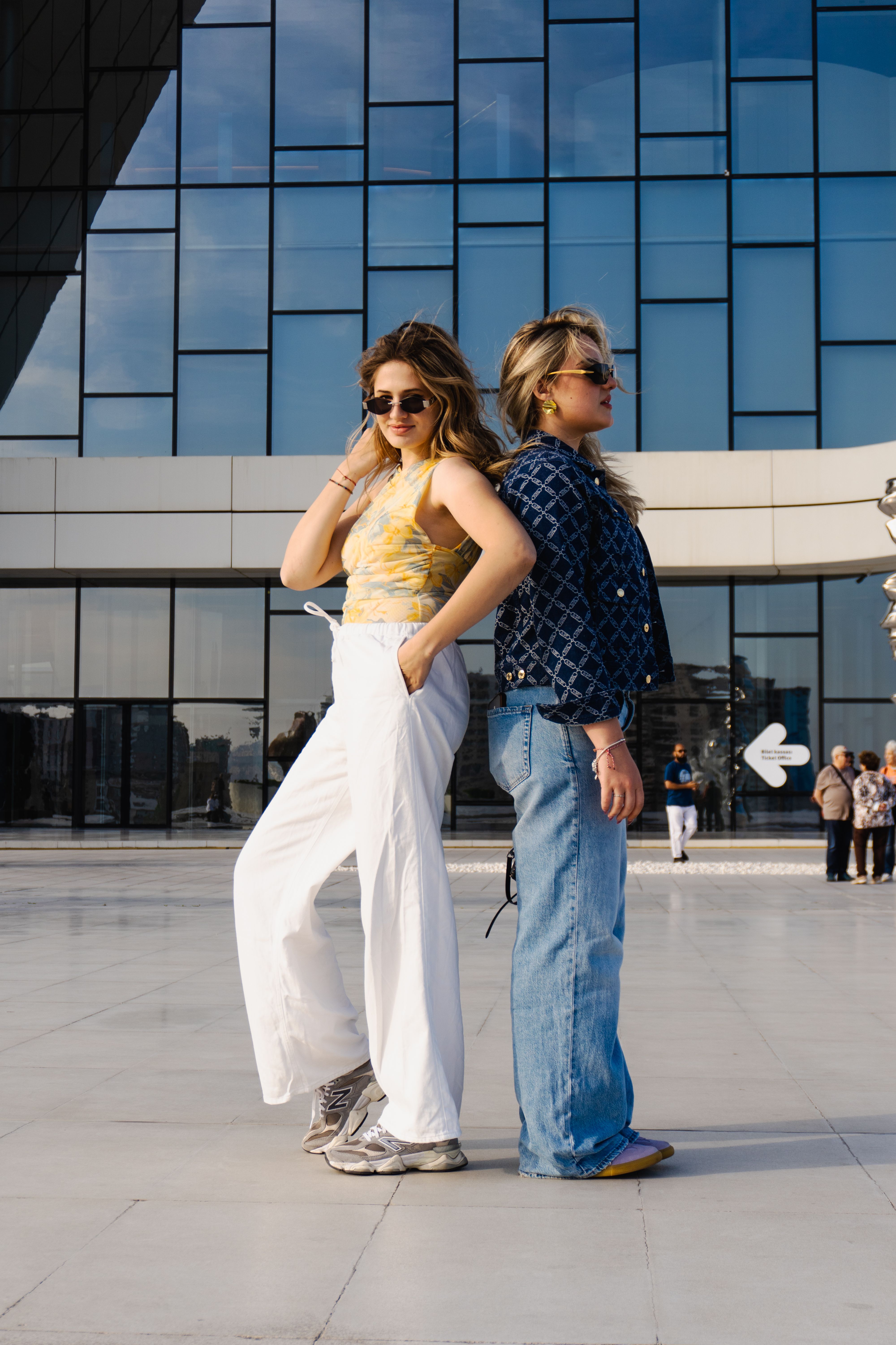 Fashionable Women Posing Outside Modern Building · Free Stock Photo