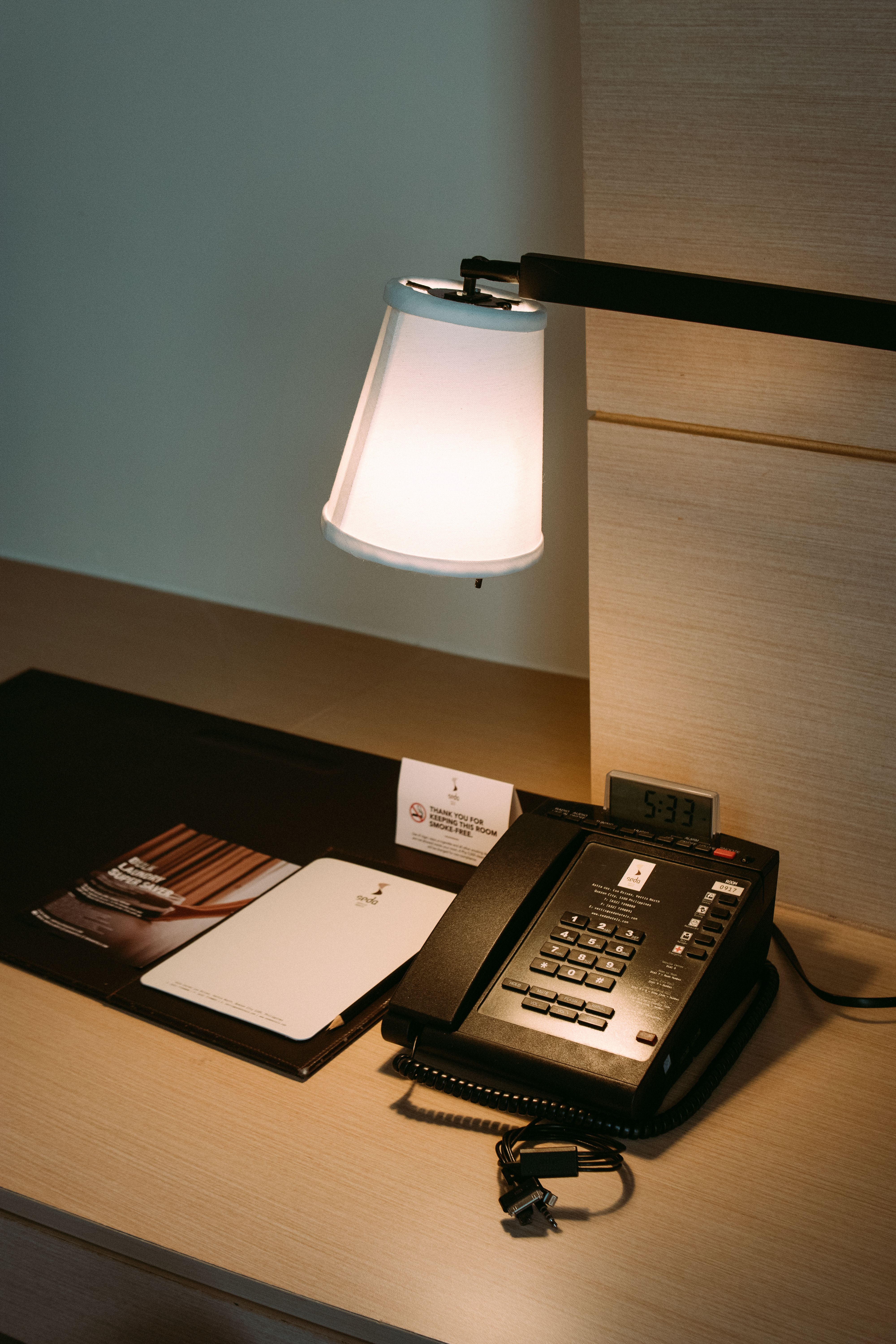 Modern Hotel Desk with Phone and Lamp · Free Stock Photo