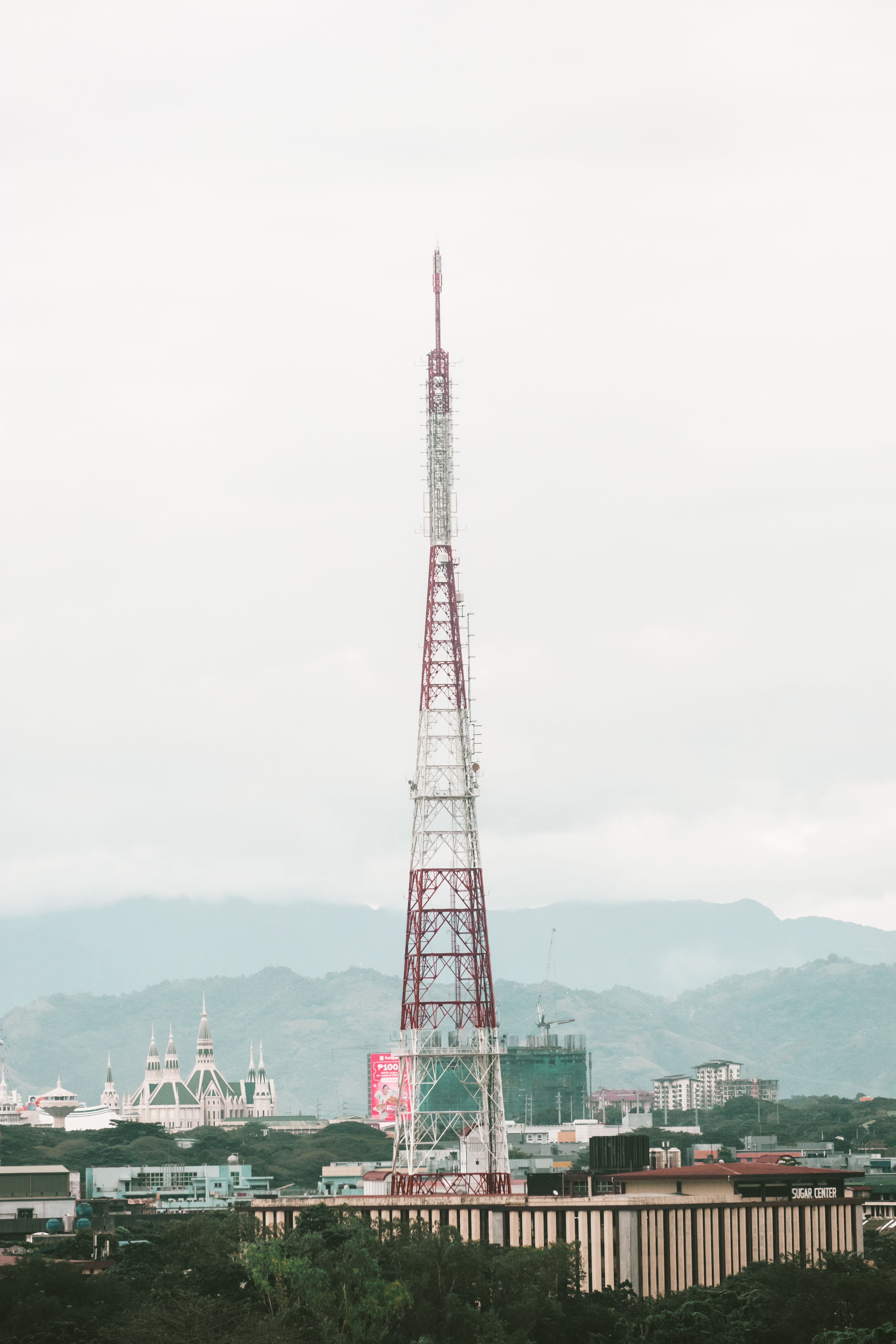Skyline View with Tower and Distant Mountains · Free Stock Photo