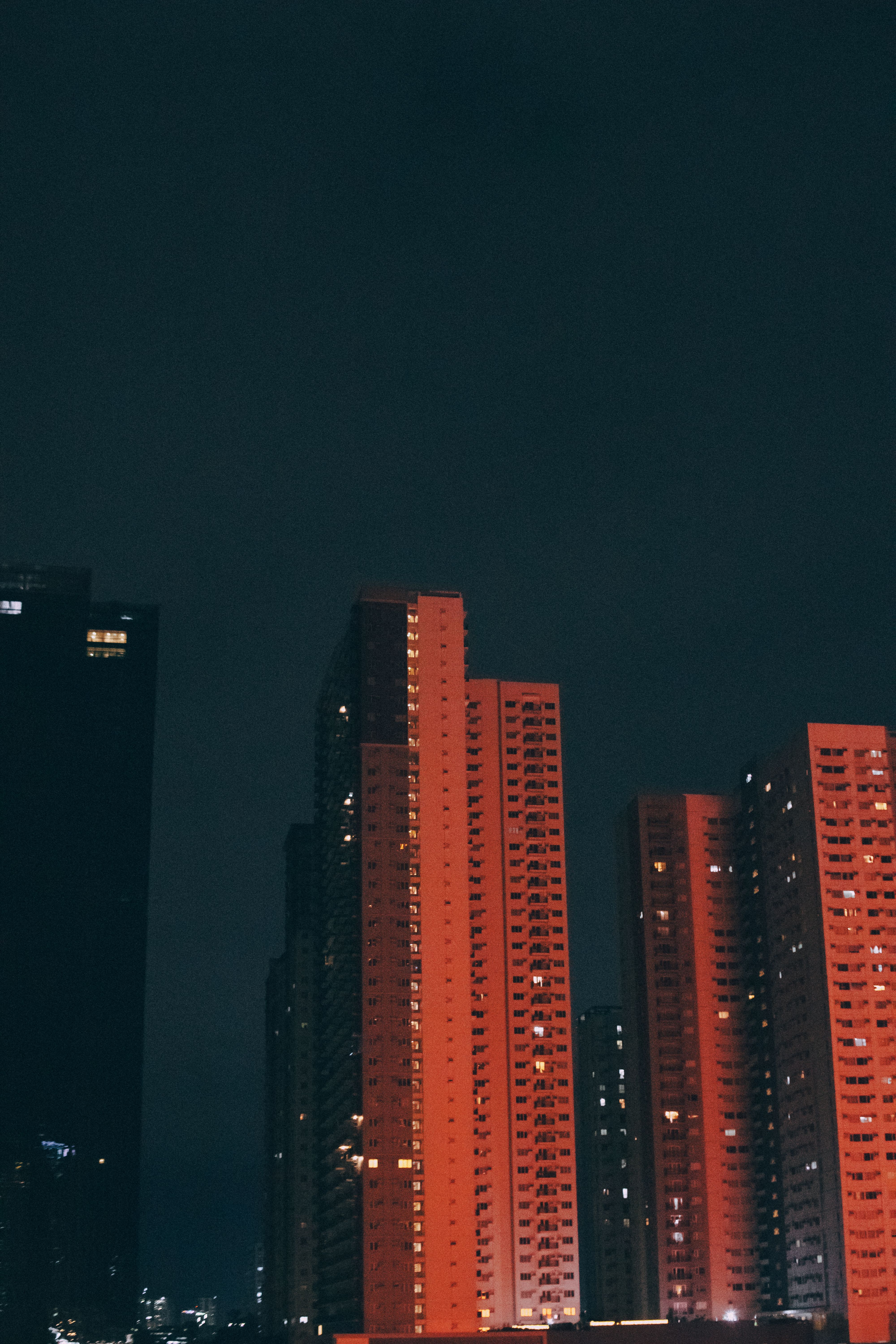 Dramatic Night Skyline with Illuminated Buildings · Free Stock Photo
