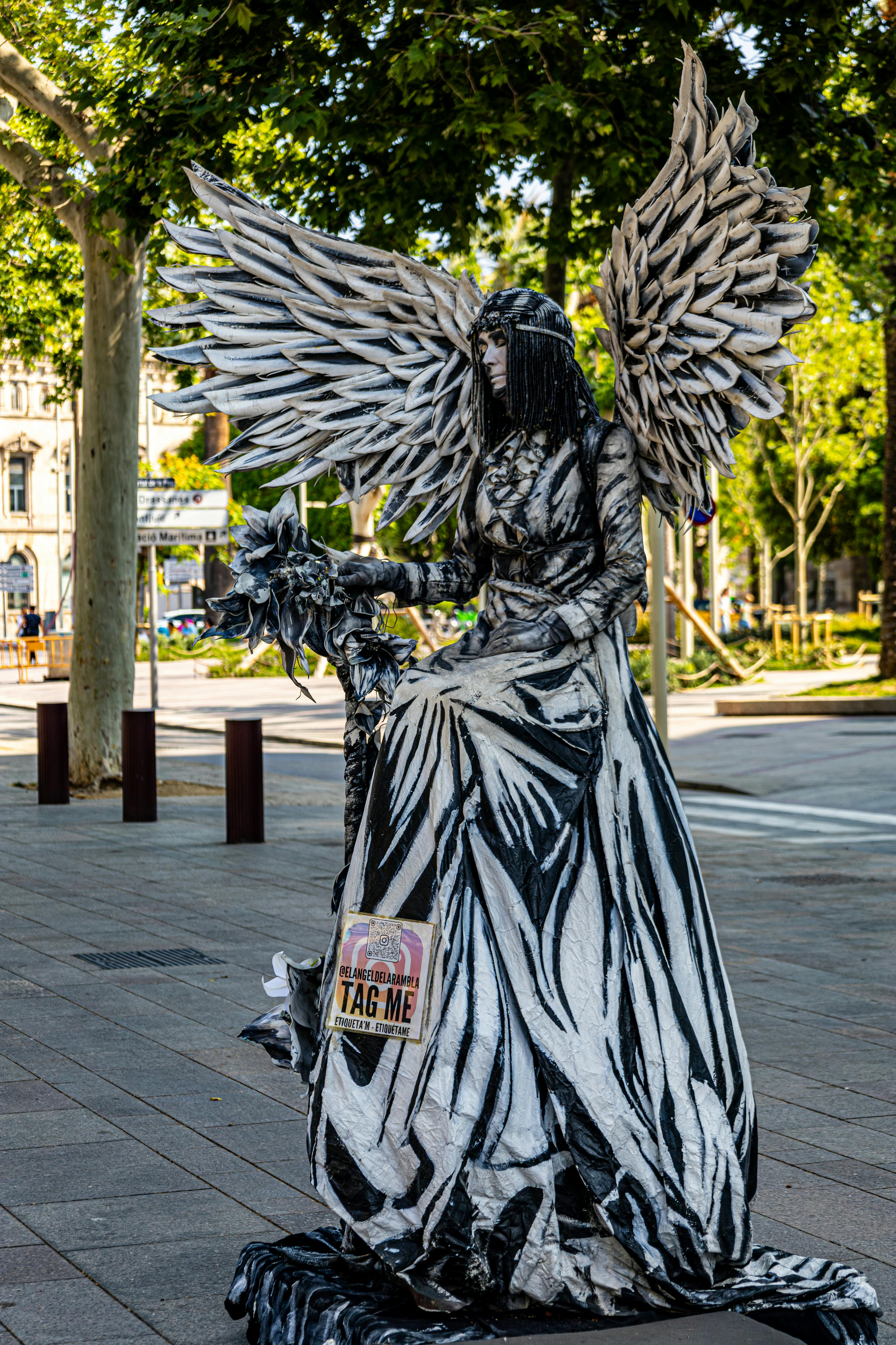 Street Performer in Angel Costume with Tag Me Sign · Free Stock Photo
