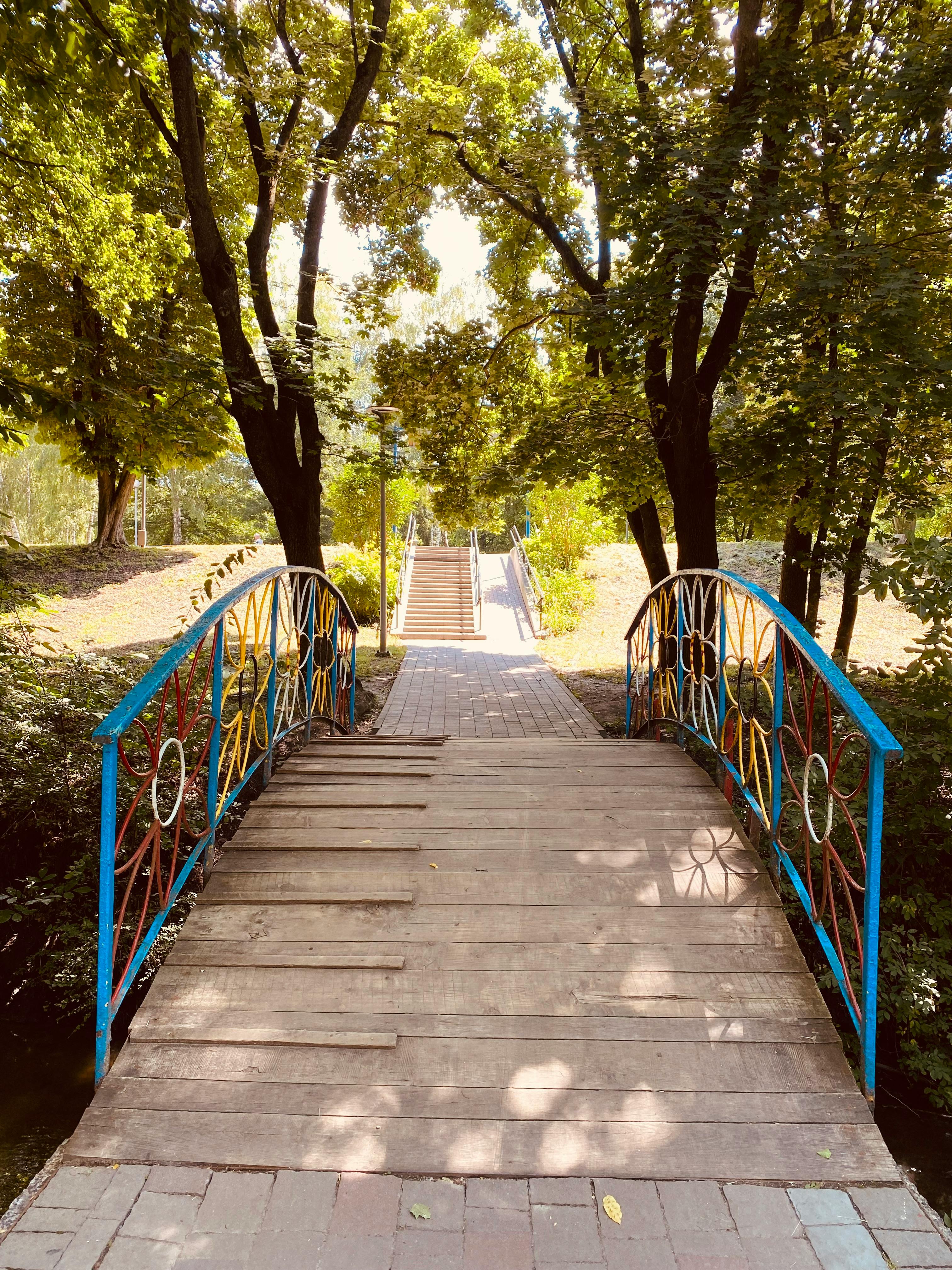 Colorful Pedestrian Bridge in Sunny Park · Free Stock Photo