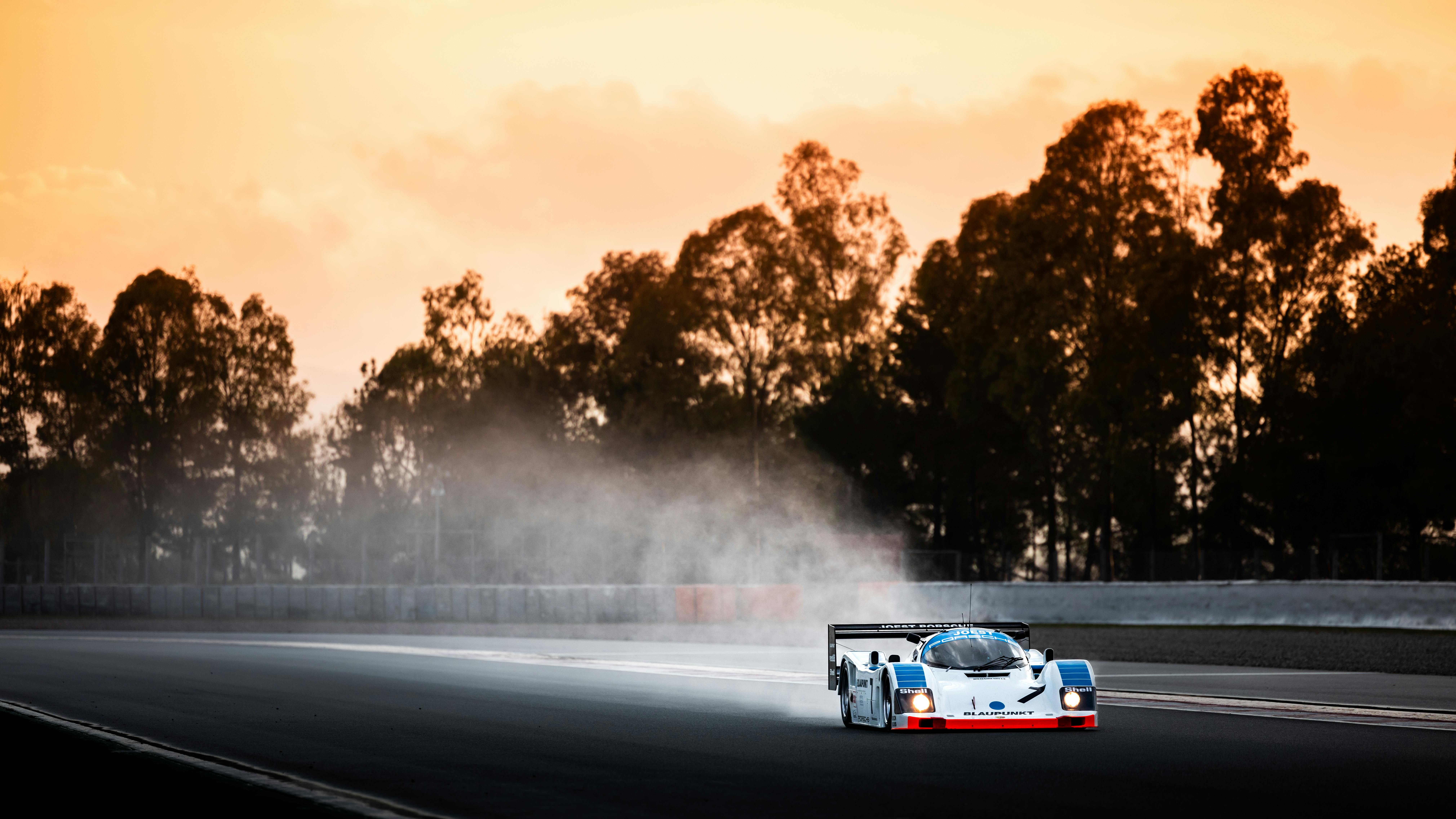 Speeding Race Car on Track at Sunset · Free Stock Photo