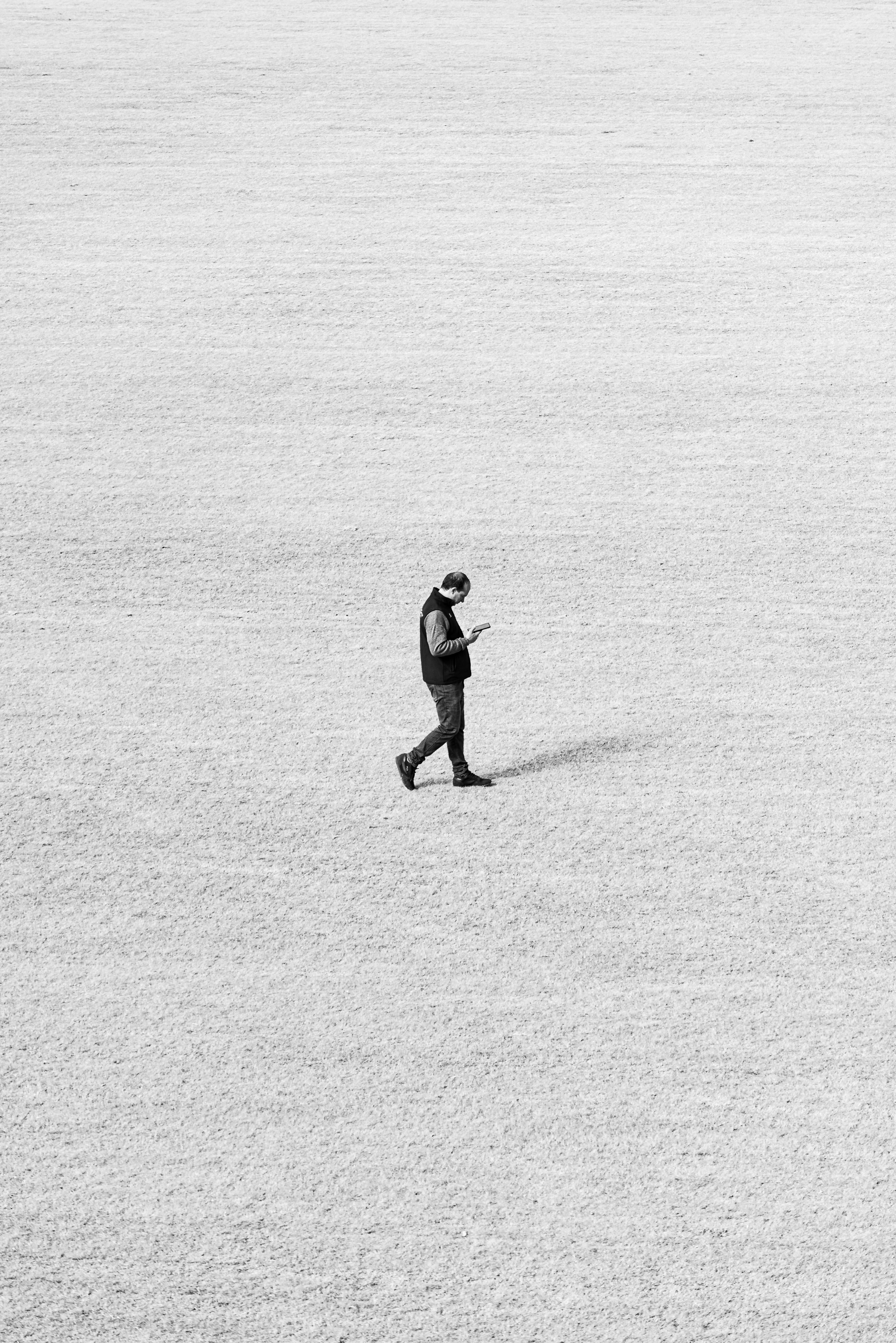 Lone Person Walking in Minimalist Landscape · Free Stock Photo