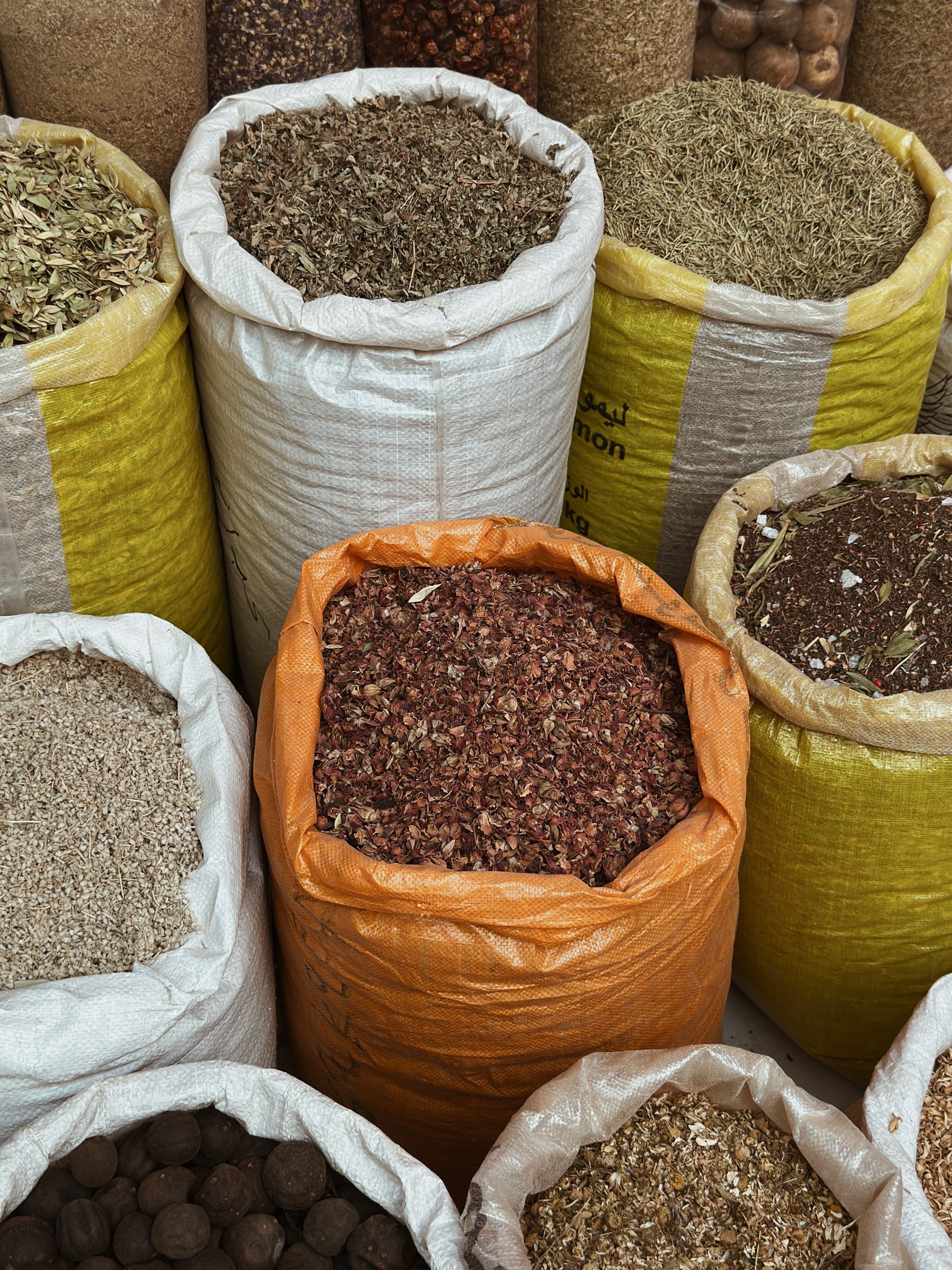 Colorful Assortment of Market Spices in Sacks · Free Stock Photo