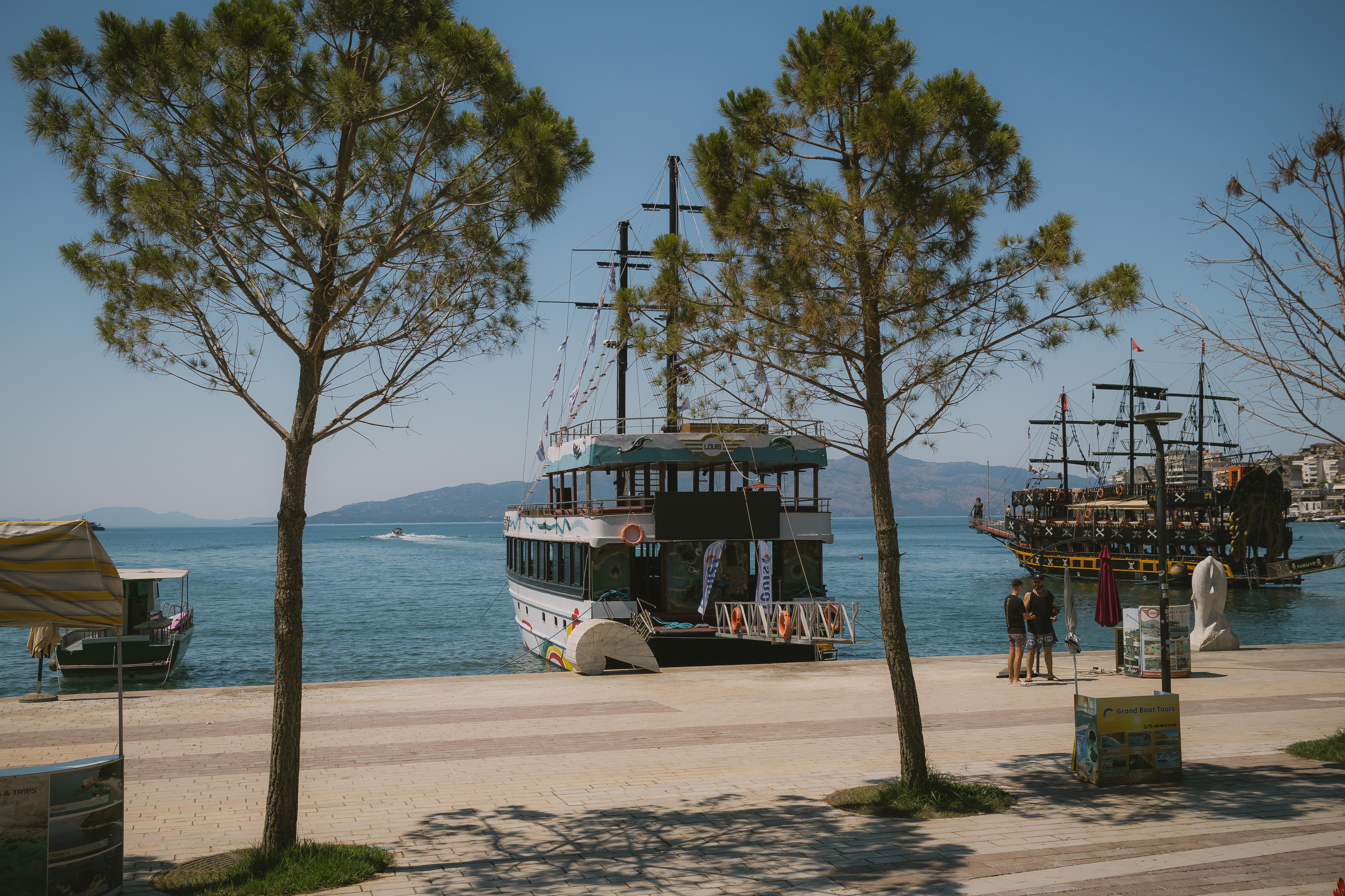 Boats Docked Along Scenic Waterfront Promenade · Free Stock Photo