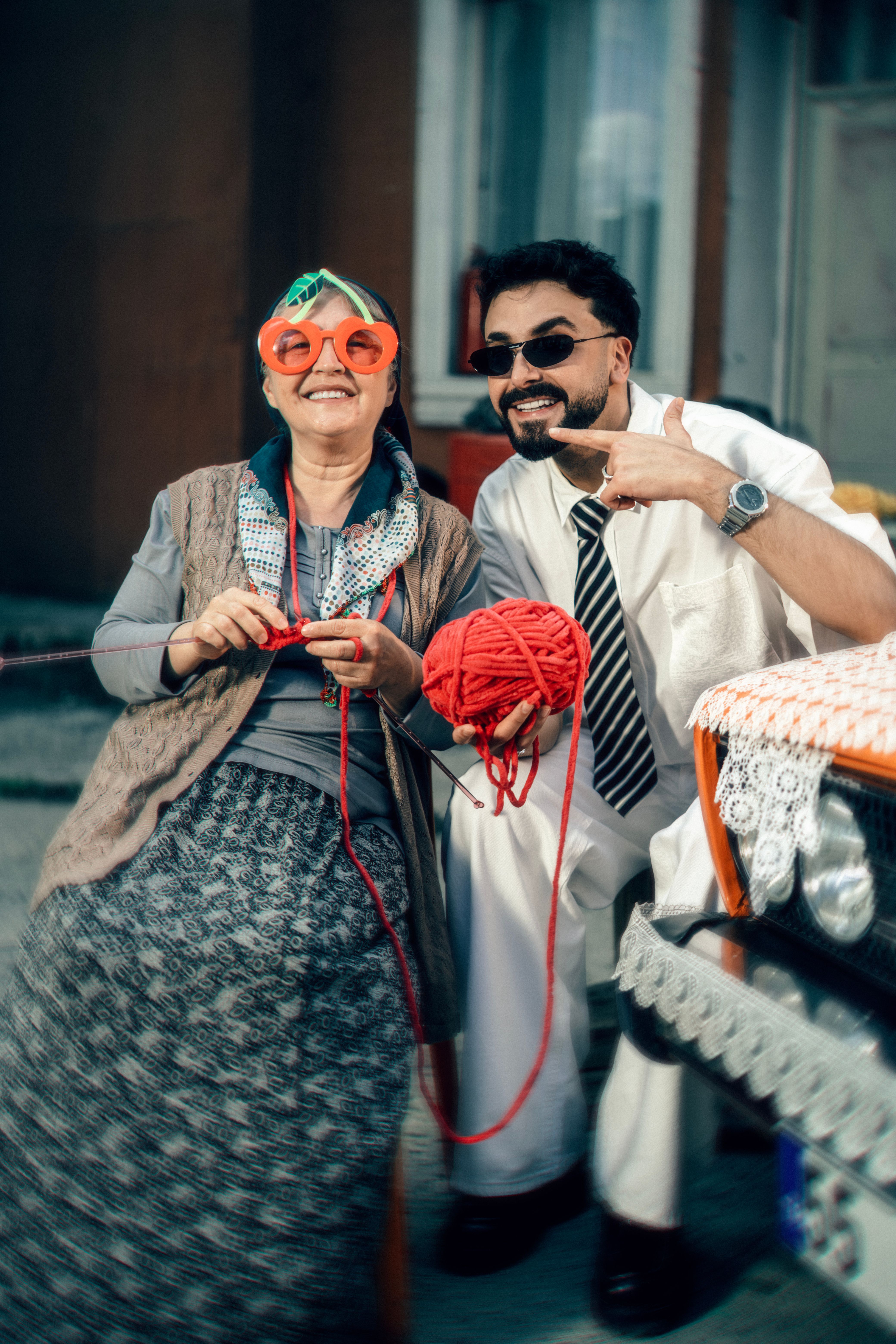 Fun Outdoor Portrait of Two Adults with Yarn · Free Stock Photo