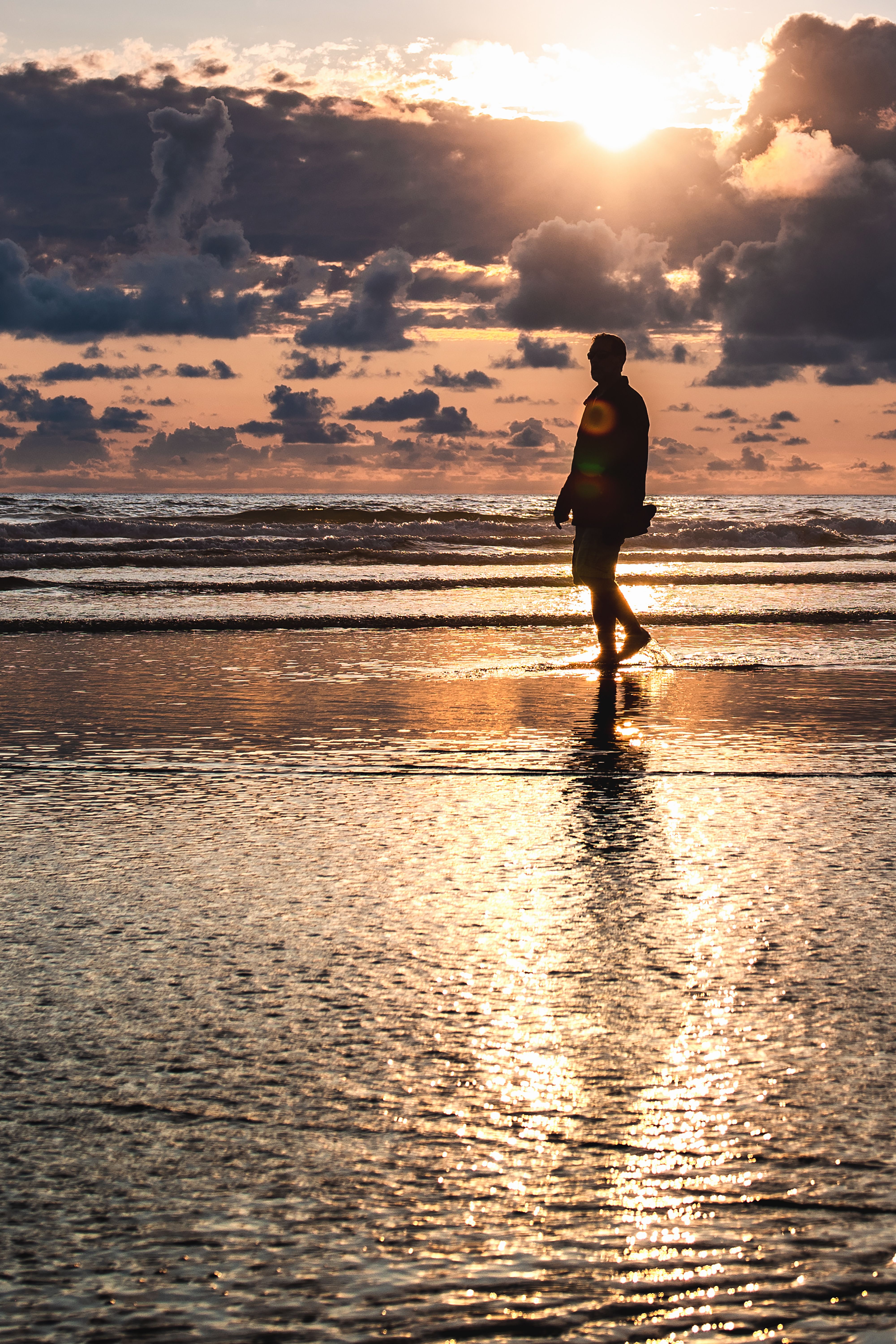 Man Walking on Seashore during Golden Hour · Free Stock Photo