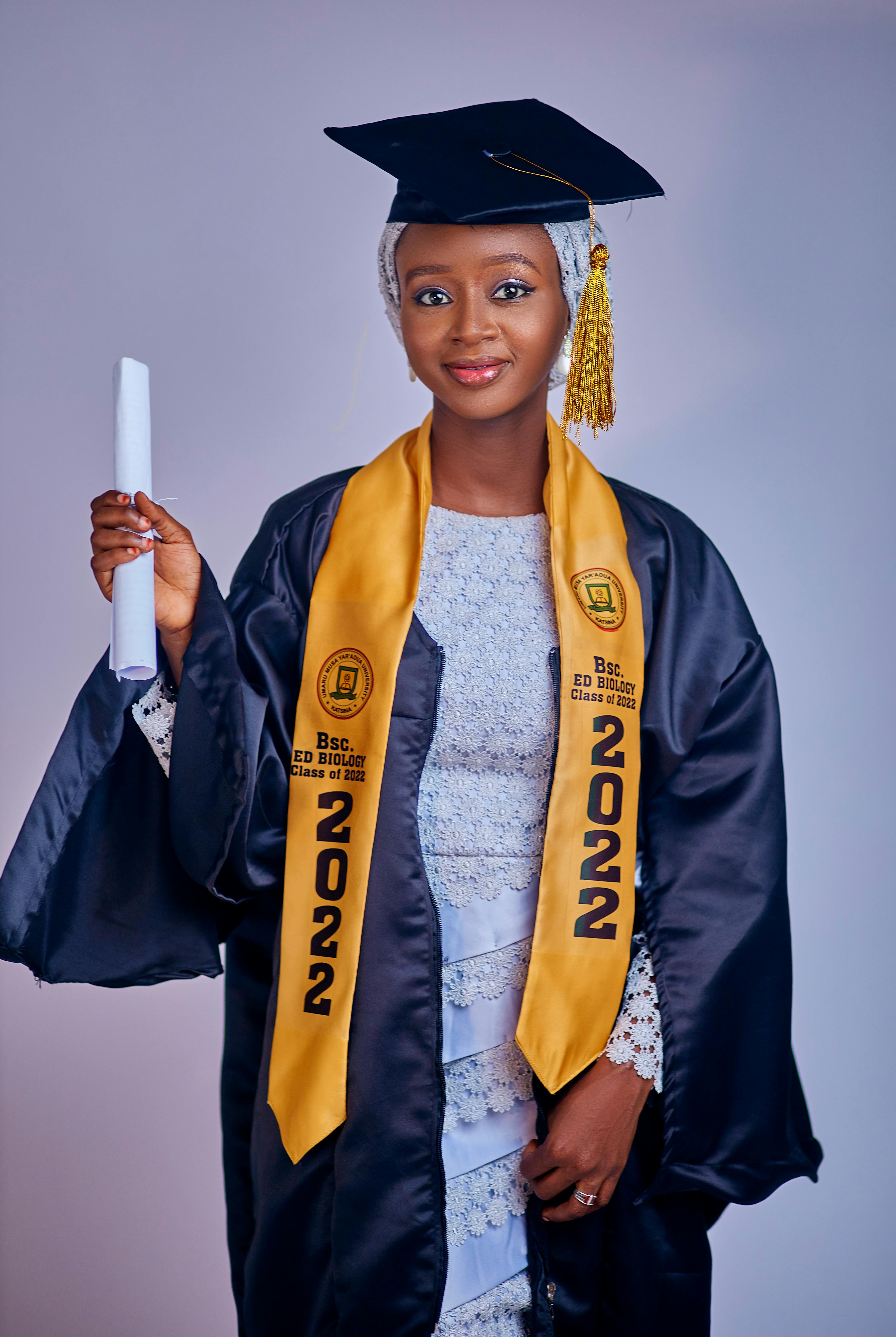 Young Graduate Posing with Diploma in Cap and Gown · Free Stock Photo