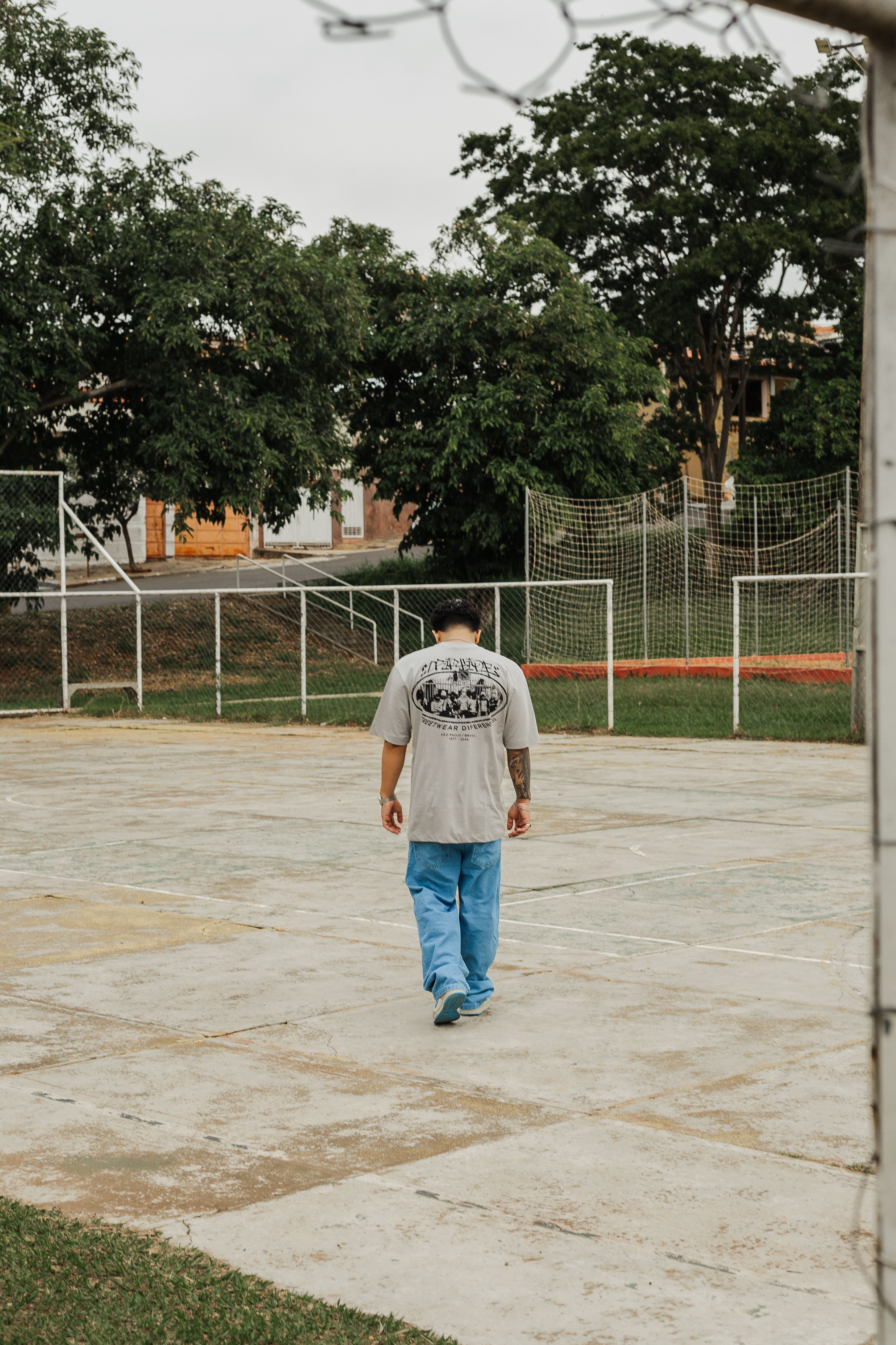 Man Walking on Outdoor Basketball Court in Brazil · Free Stock Photo