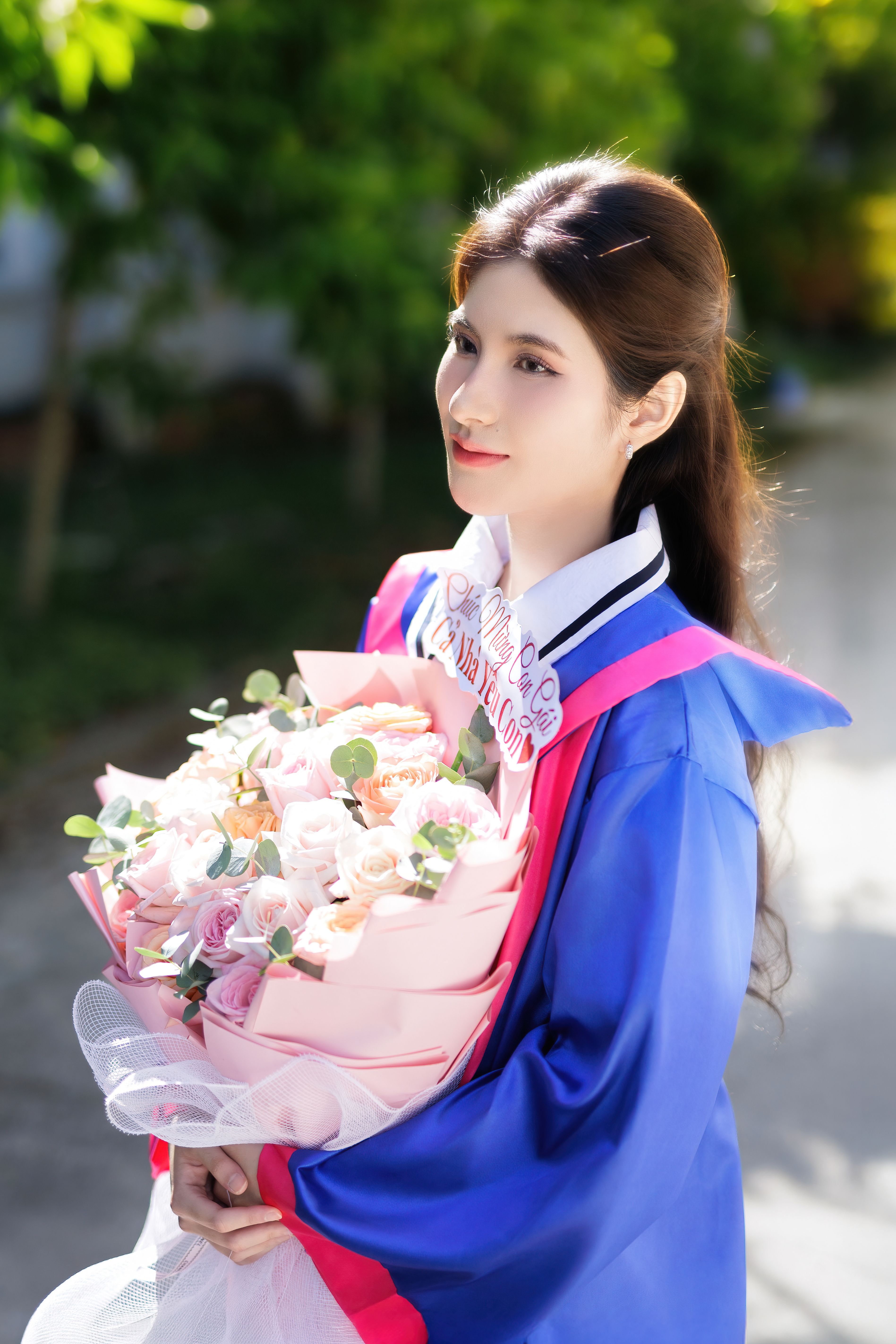 Graduation Celebration with Bouquet of Roses · Free Stock Photo