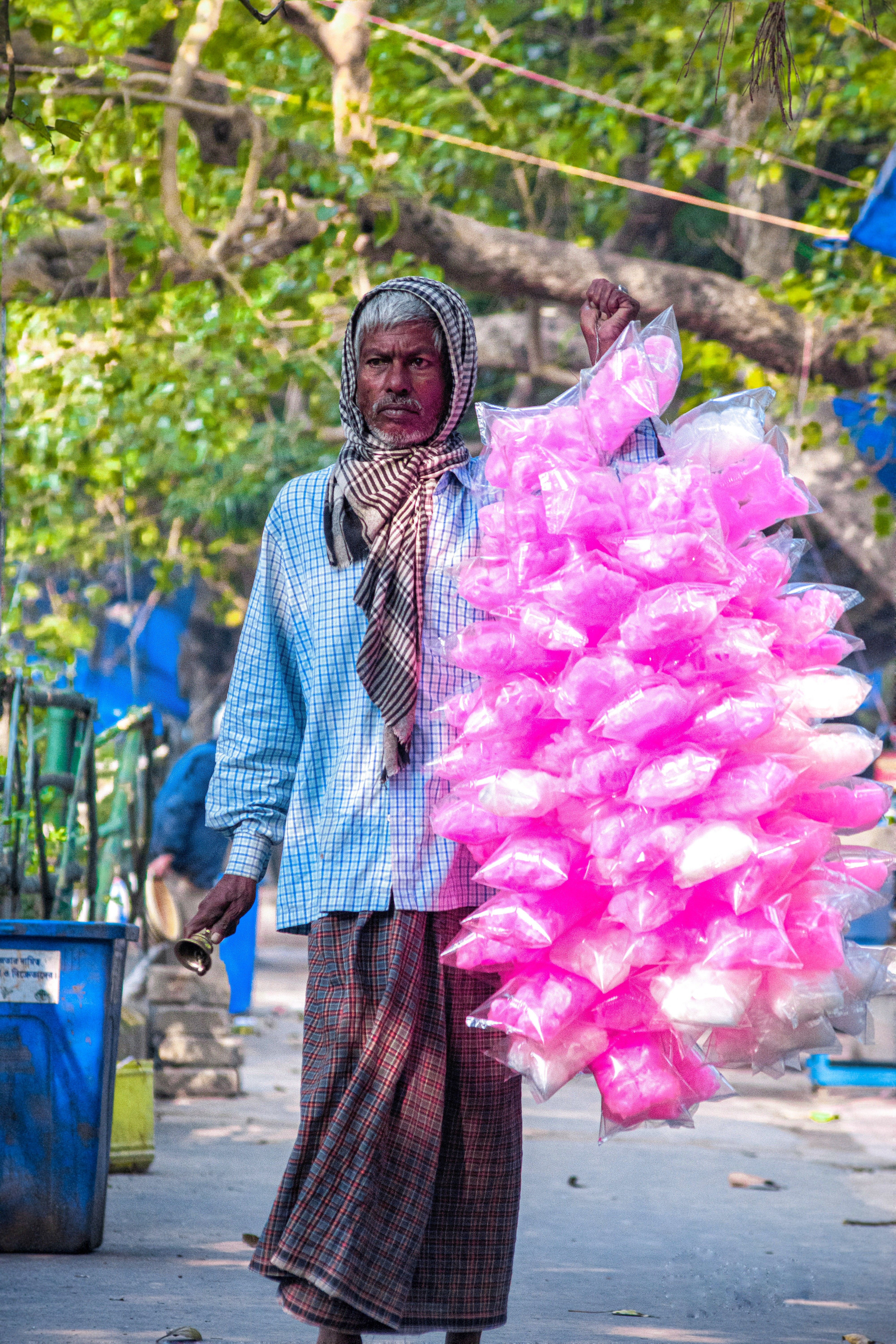 Street Vendor Selling Cotton Candy in Colorful Setting · Free Stock Photo