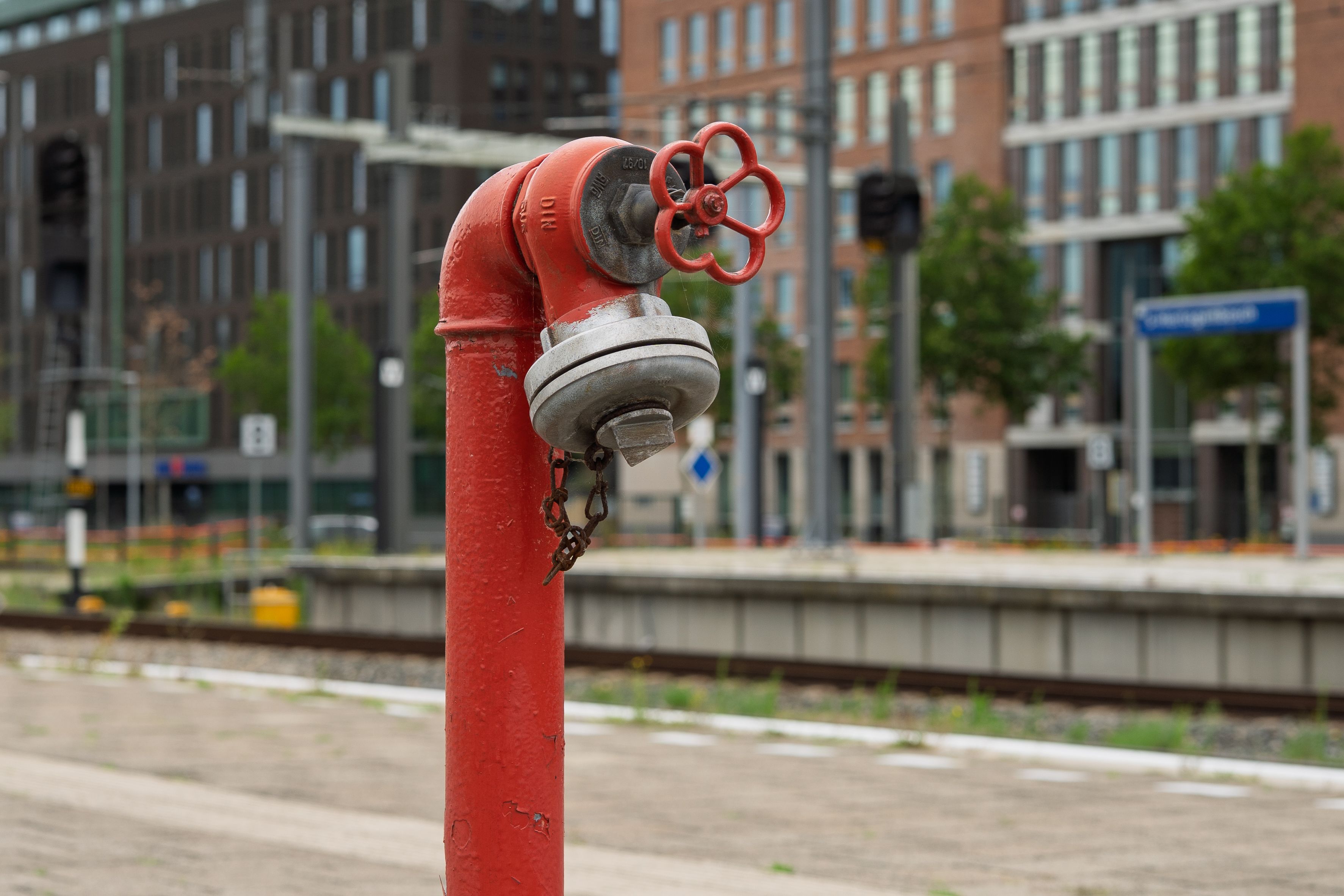 Urban Fire Hydrant Near Railway Station · Free Stock Photo