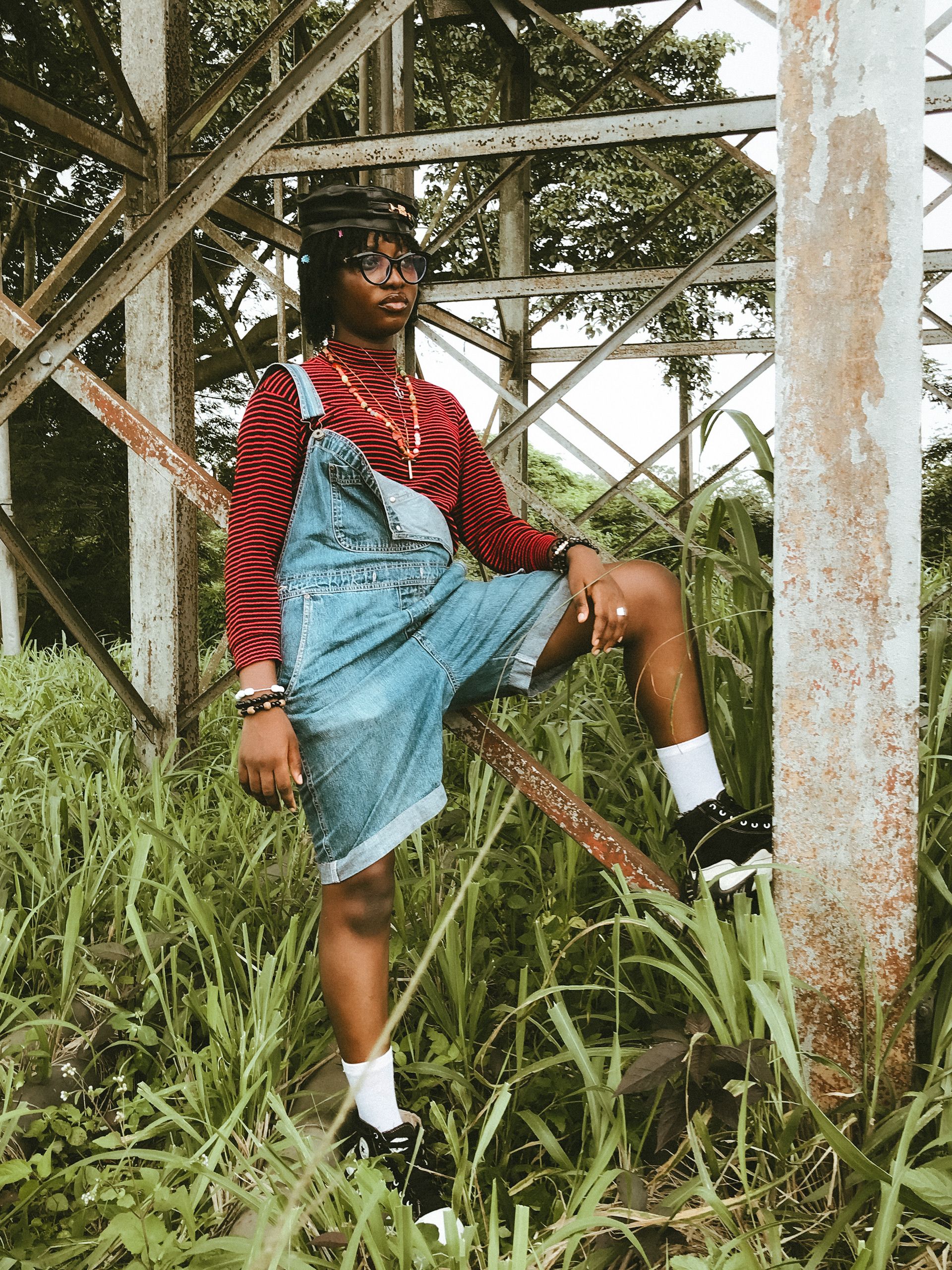 Trendy Individual Posing Outdoors in Overalls · Free Stock Photo