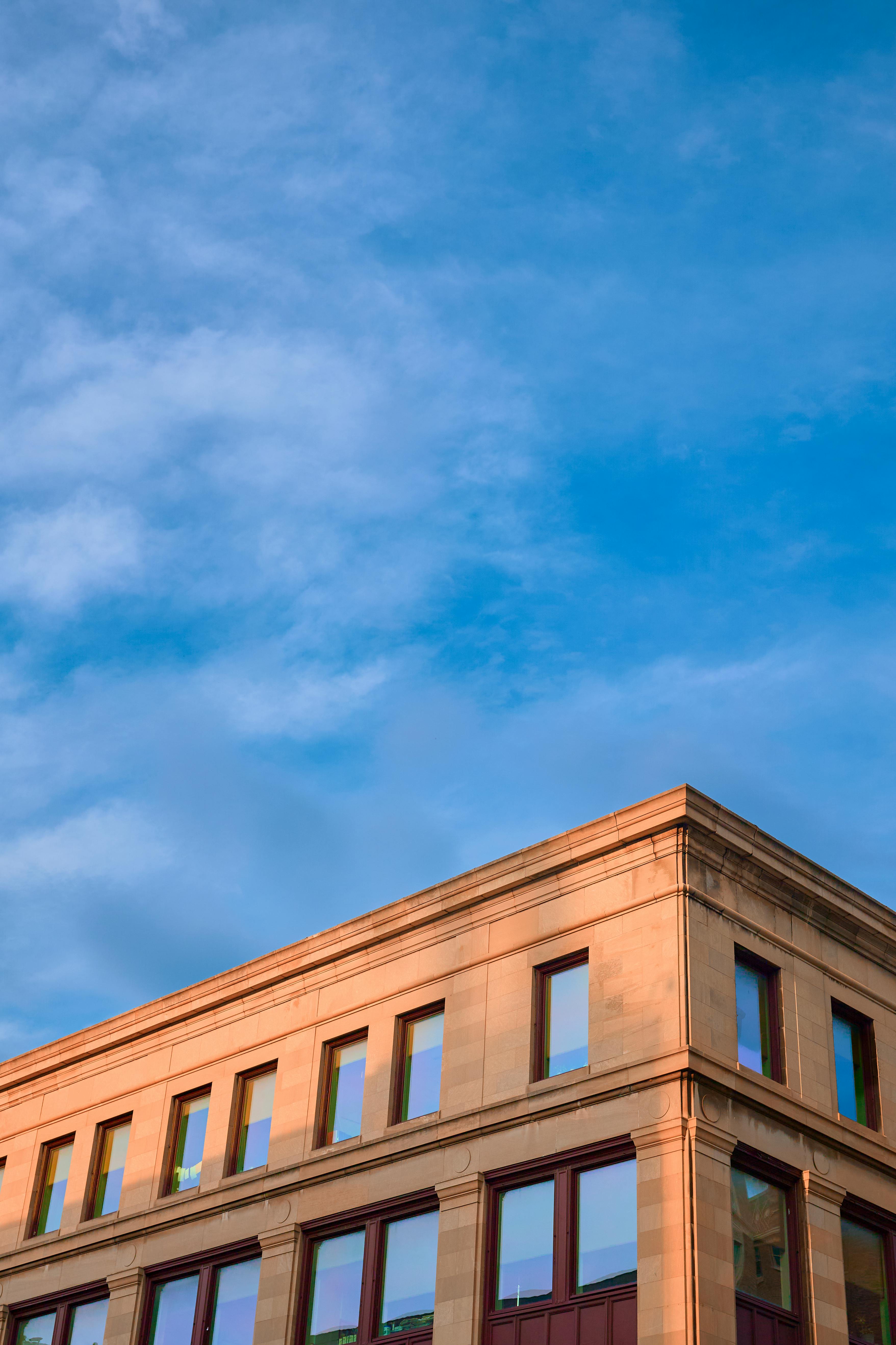 Elegant Building Corner with Blue Sky Background · Free Stock Photo
