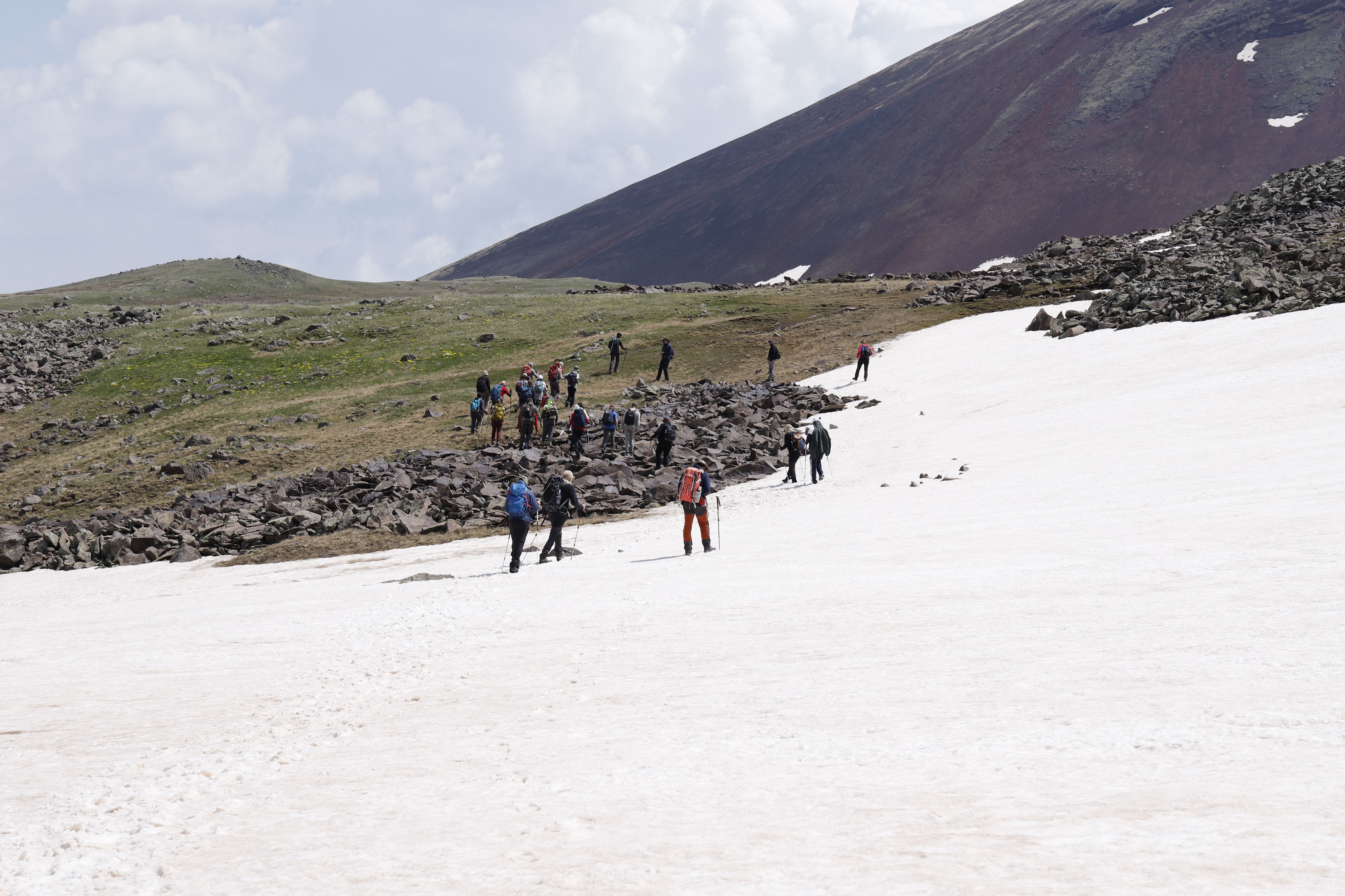 Group of Hikers Ascending Snowy Mountain Trail · Free Stock Photo