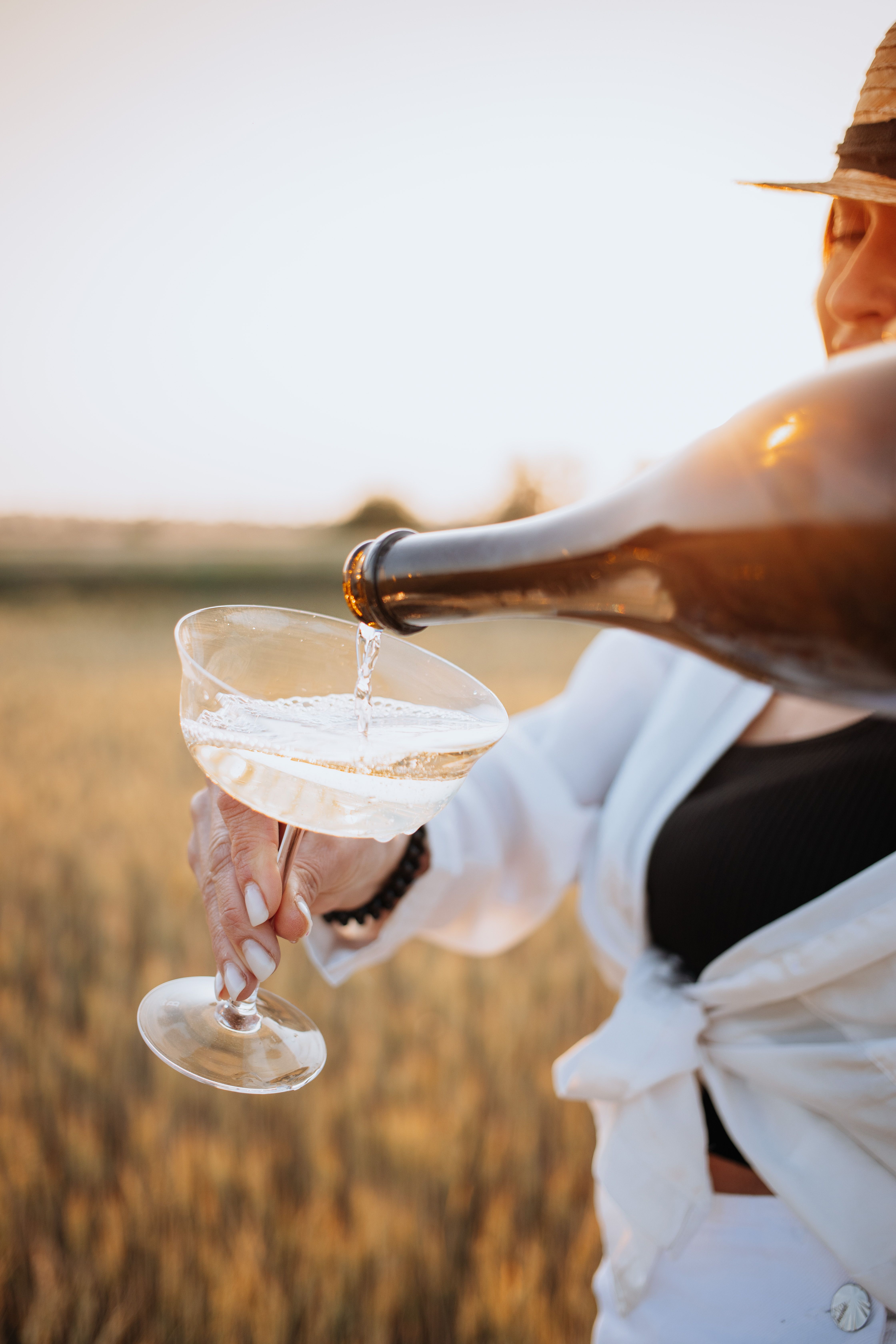 Sunset Champagne Pour in Wheat Field · Free Stock Photo