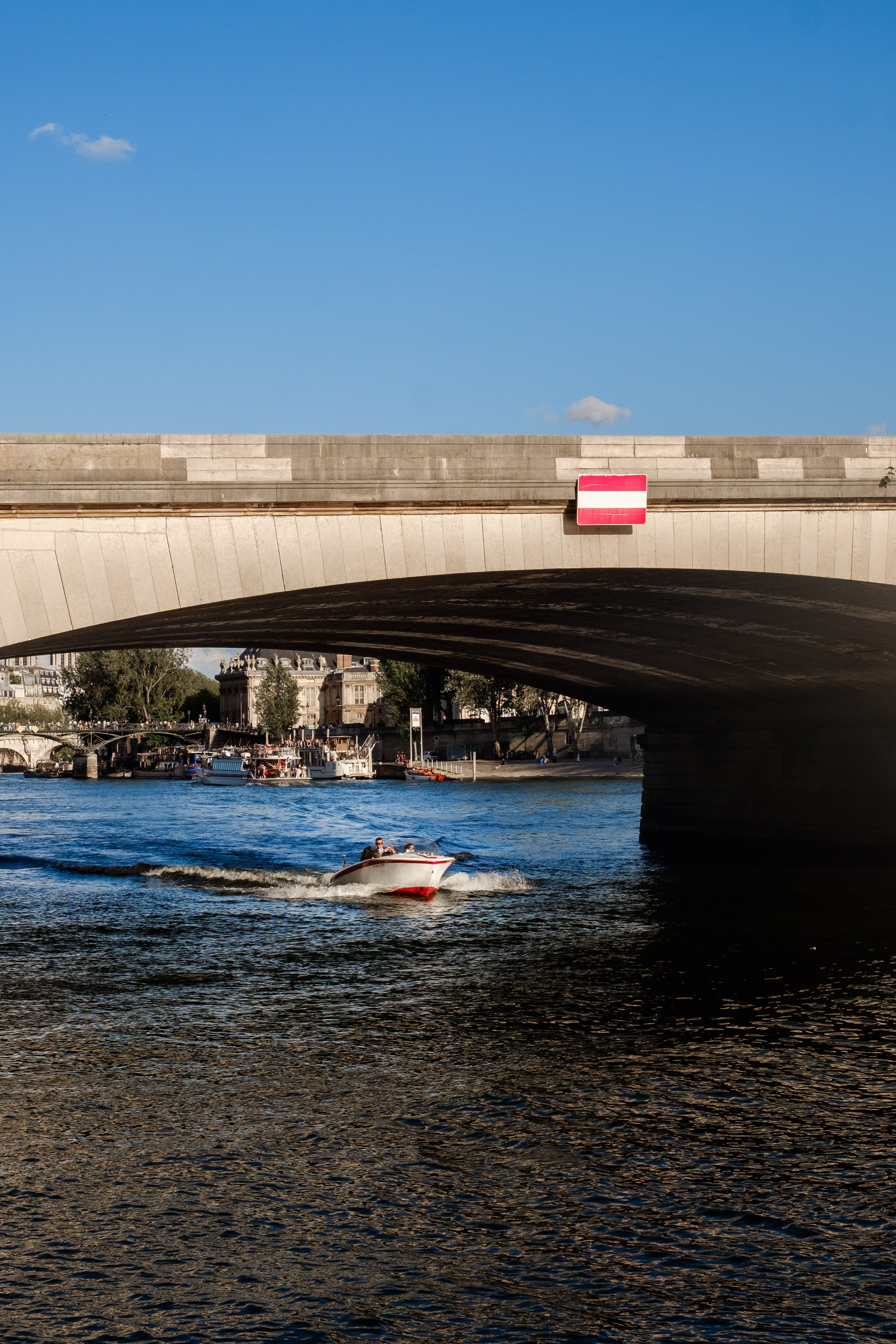 Speedboat under Urban Bridge on Sunny Day · Free Stock Photo