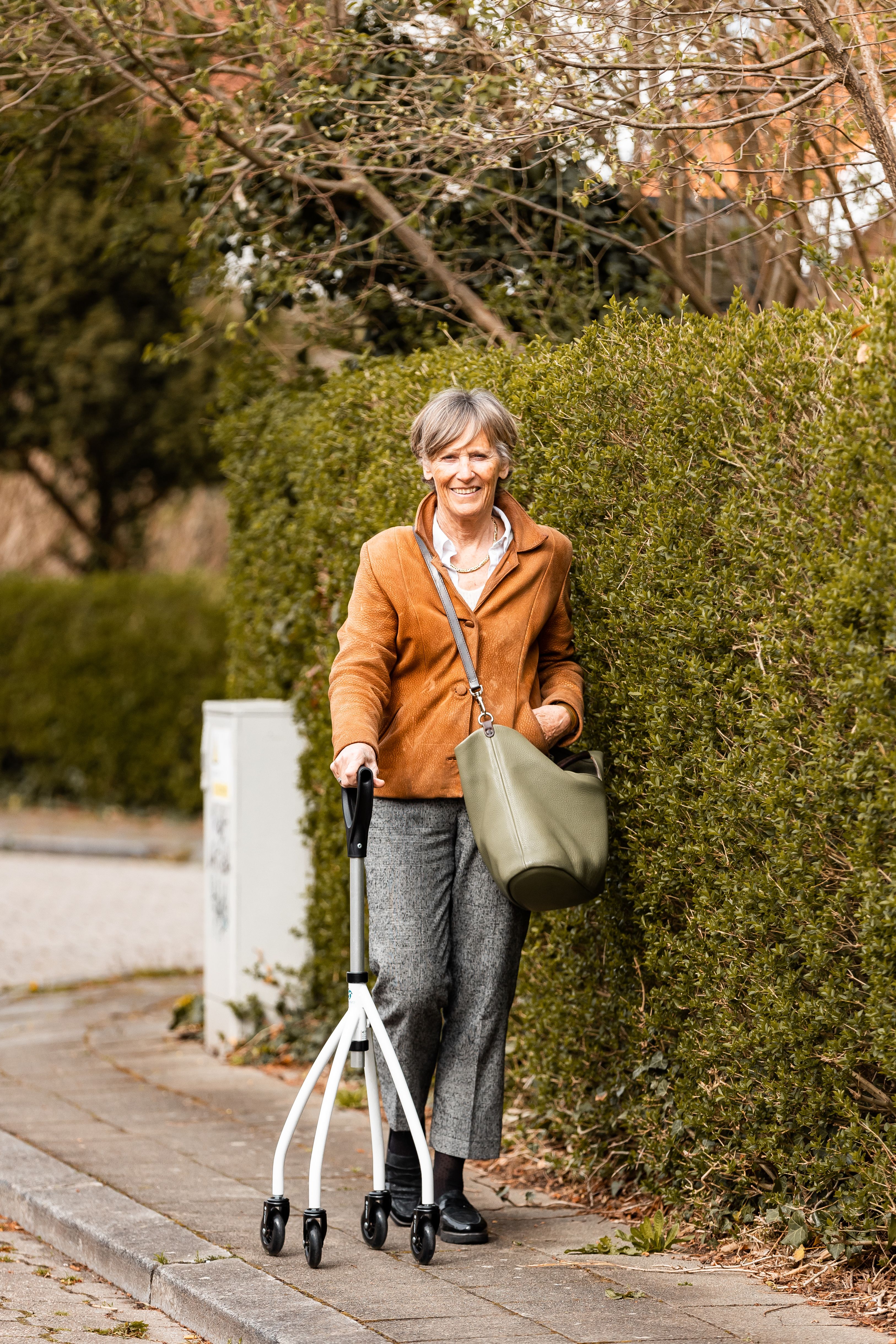 Senior Woman Walking with Rollator Outdoors · Free Stock Photo