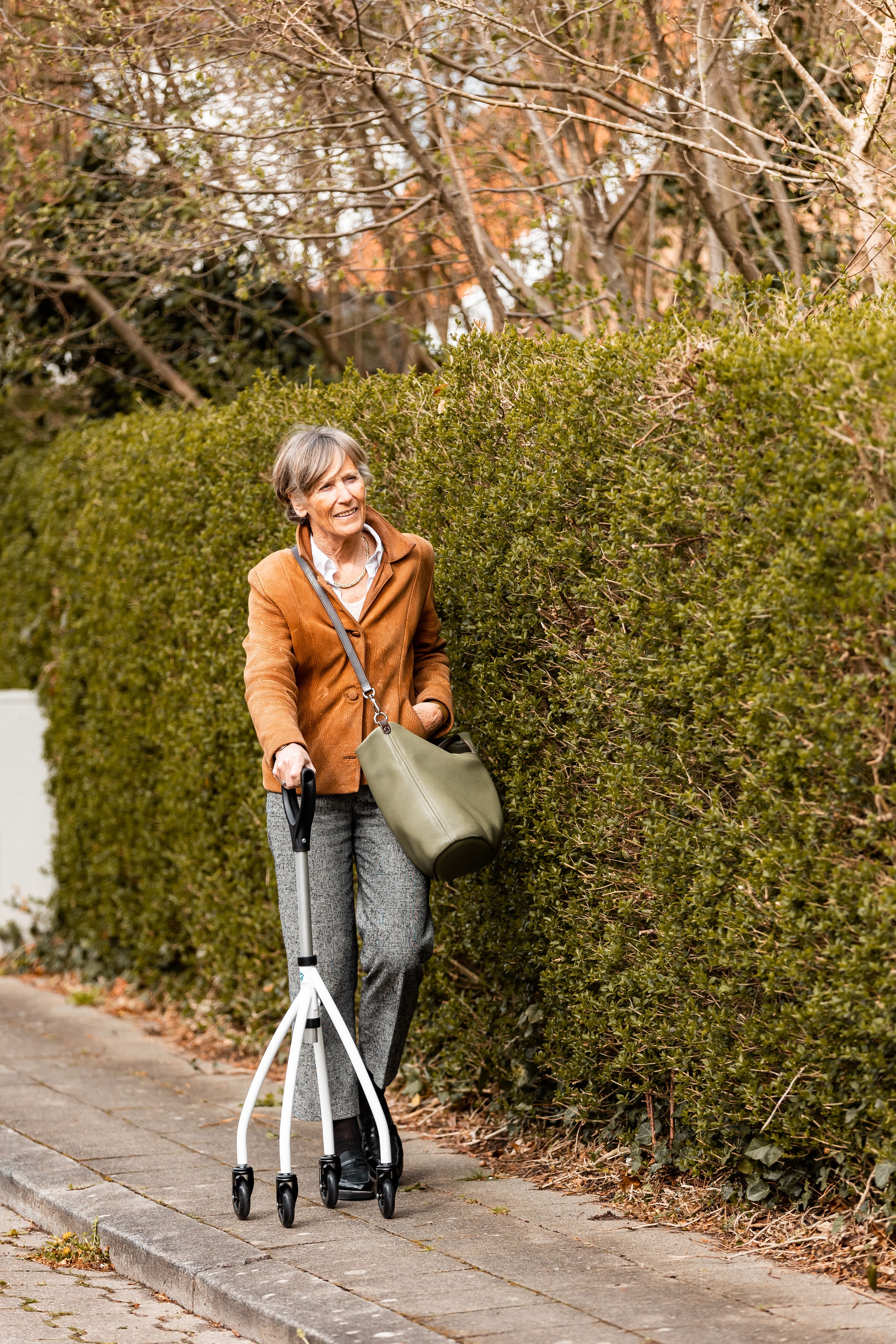 Senior Woman Walking with Rollator Outdoors · Free Stock Photo