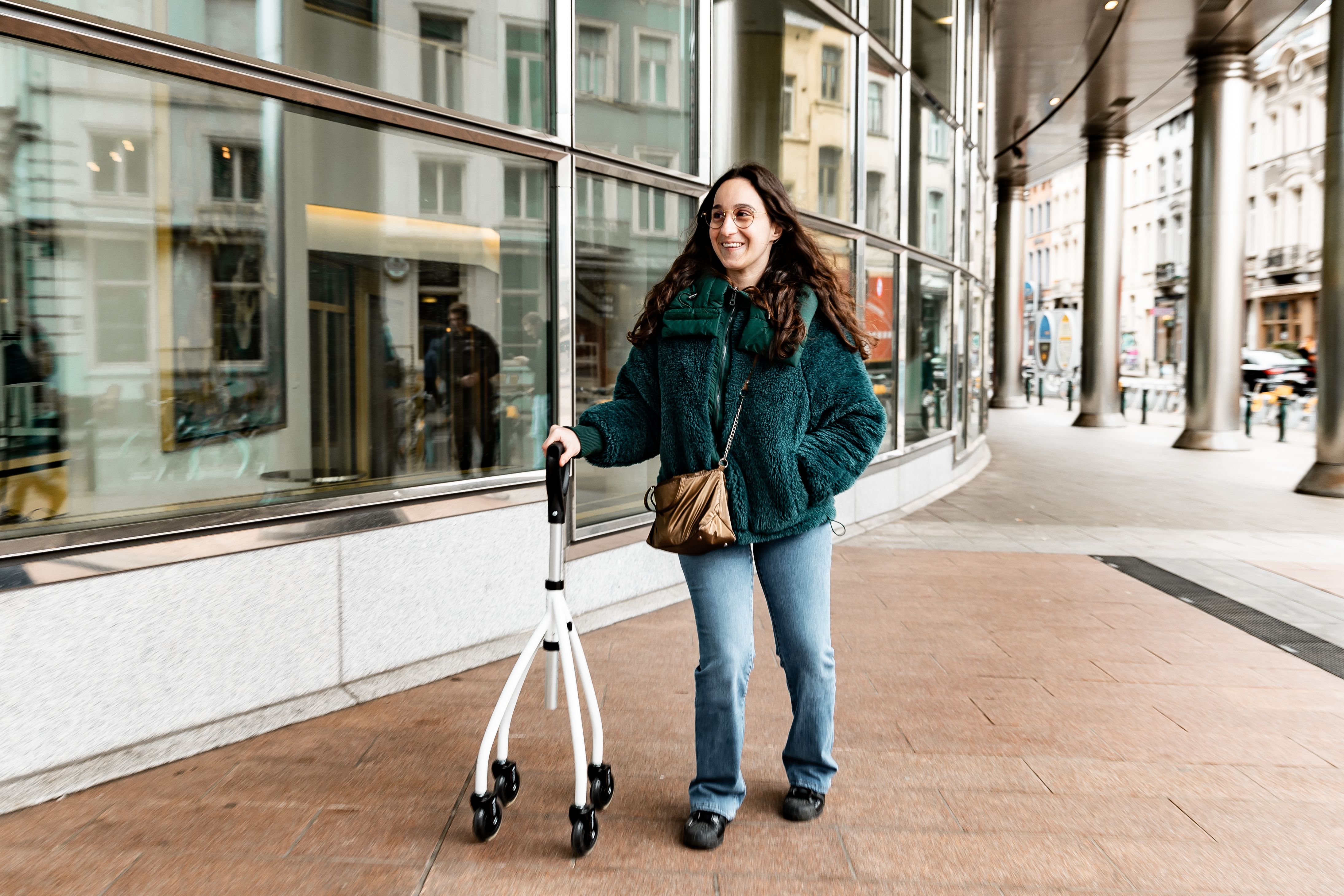 Smiling Woman Walking with Rollator Outdoors · Free Stock Photo