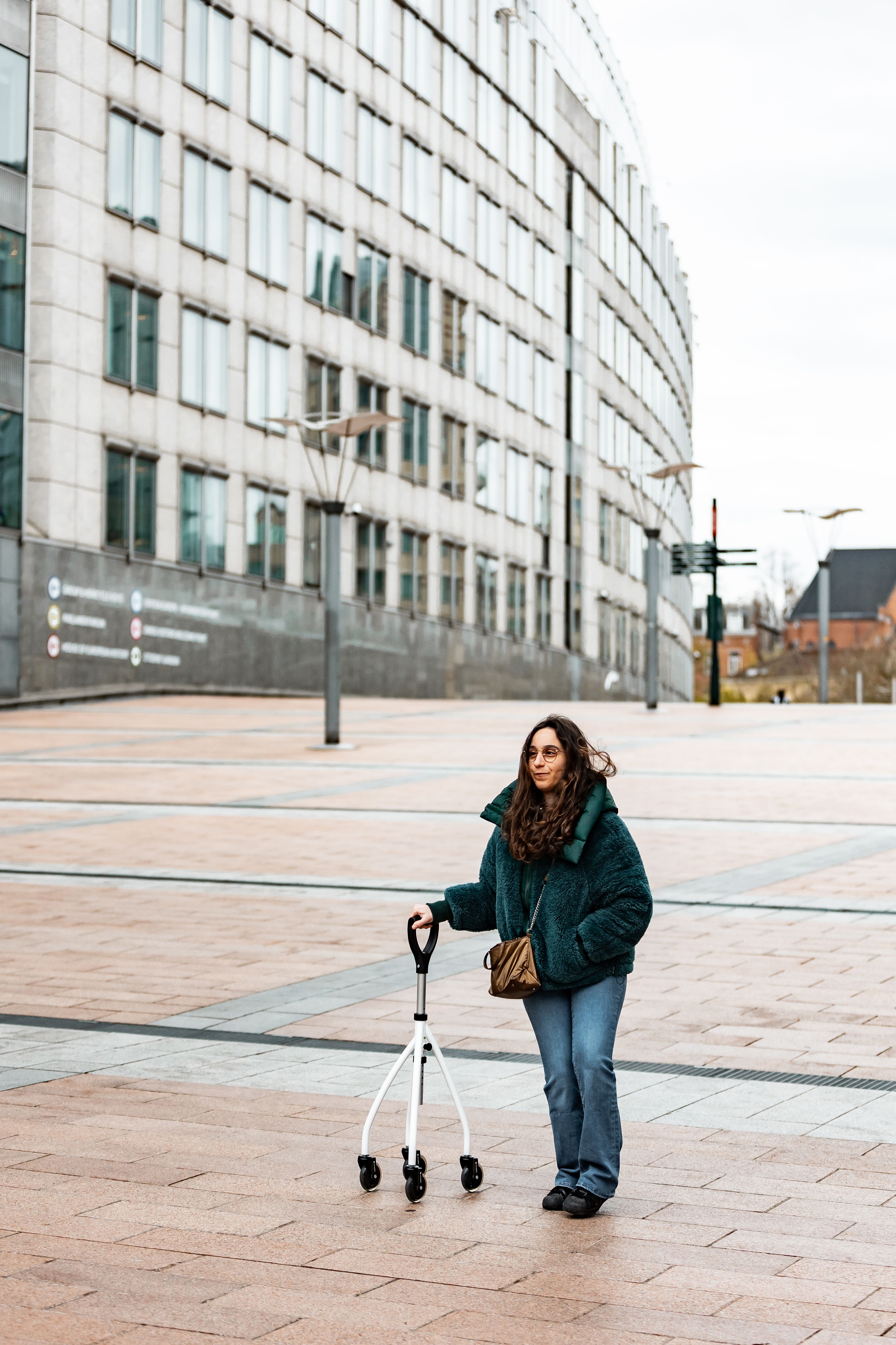 Woman using rollator on urban street · Free Stock Photo