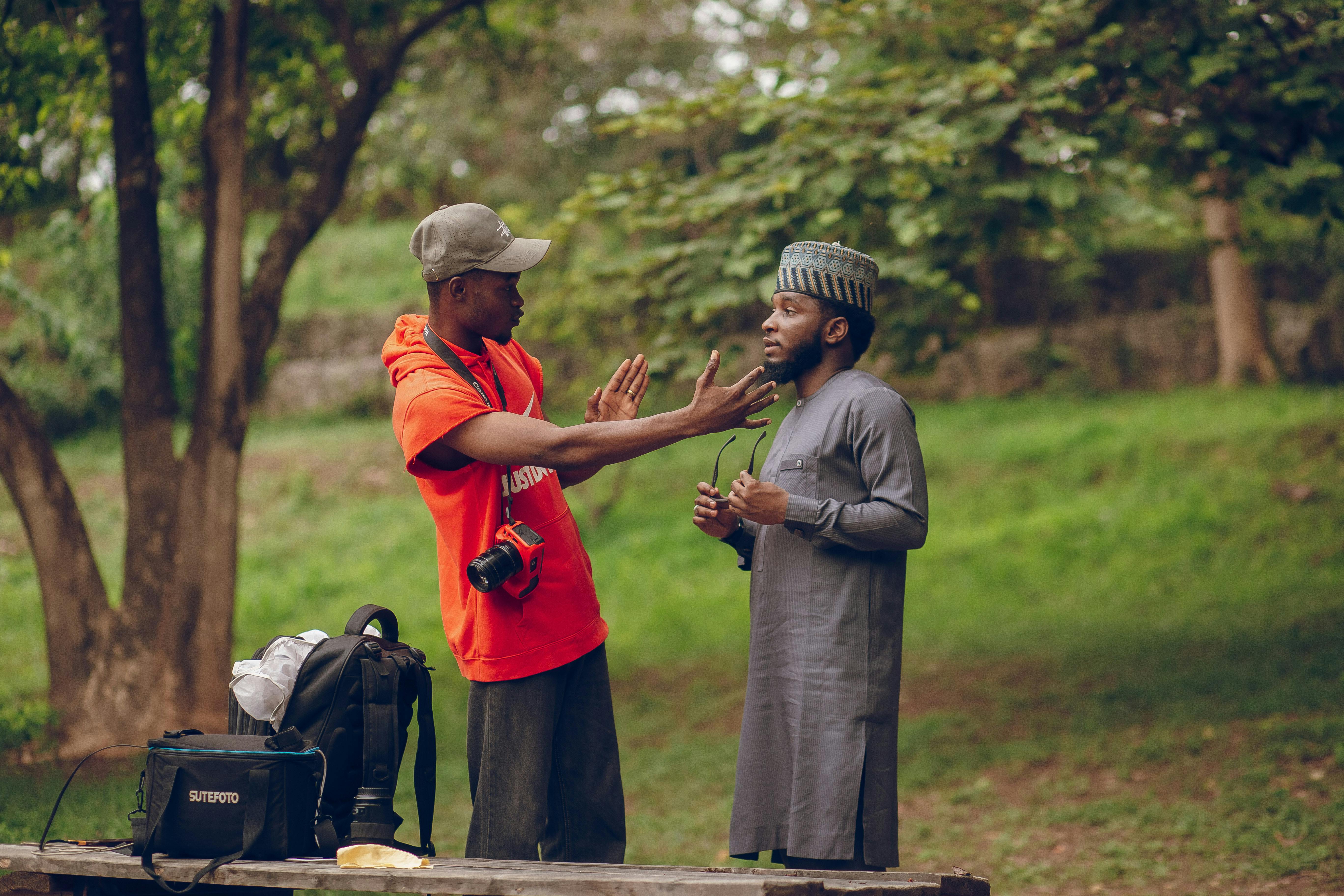 Two men engaging in outdoor conversation · Free Stock Photo