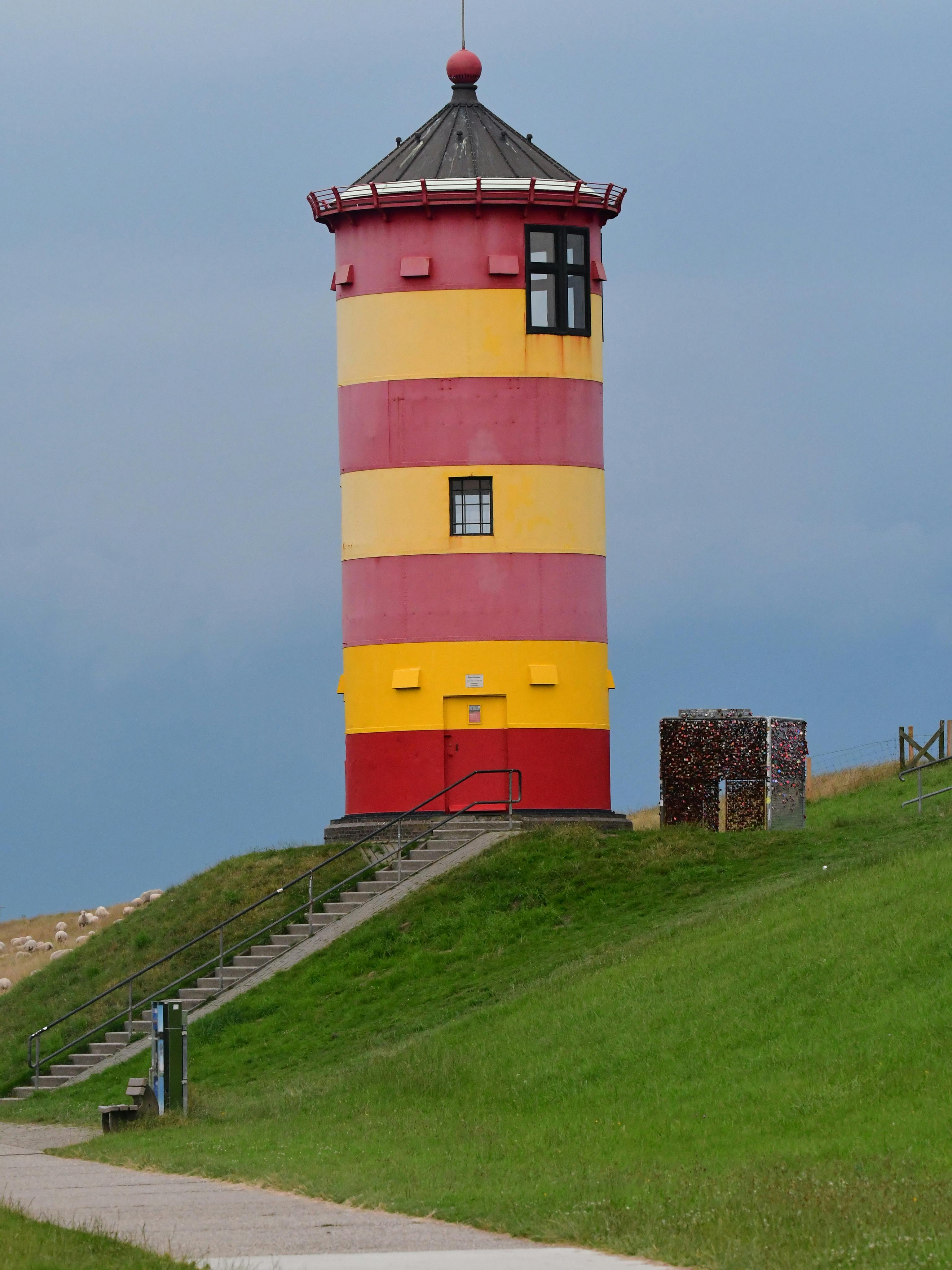 Colorful Pilsum Lighthouse Amidst Green Landscape · Free Stock Photo