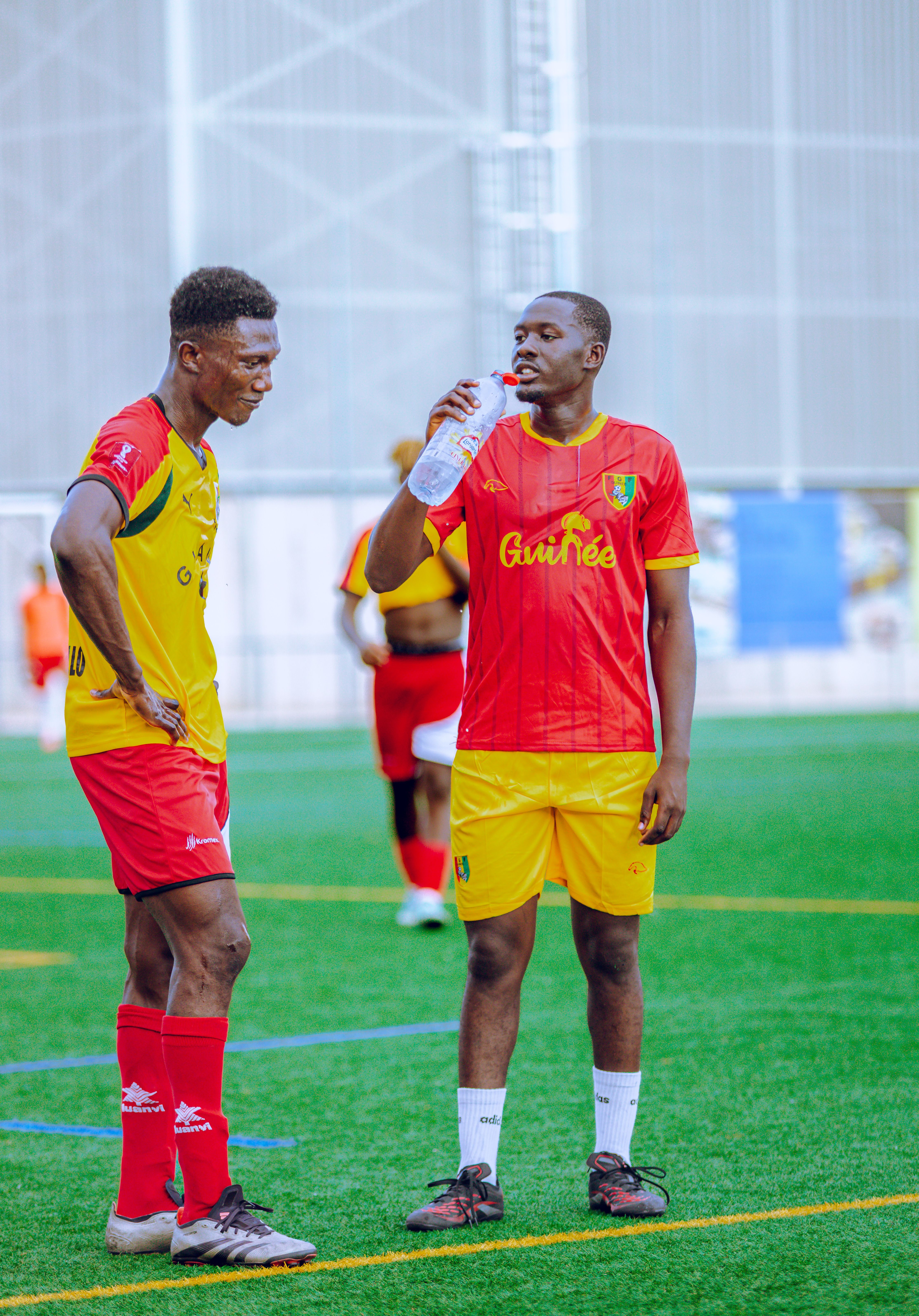Soccer Players Hydrating During Game Break · Free Stock Photo