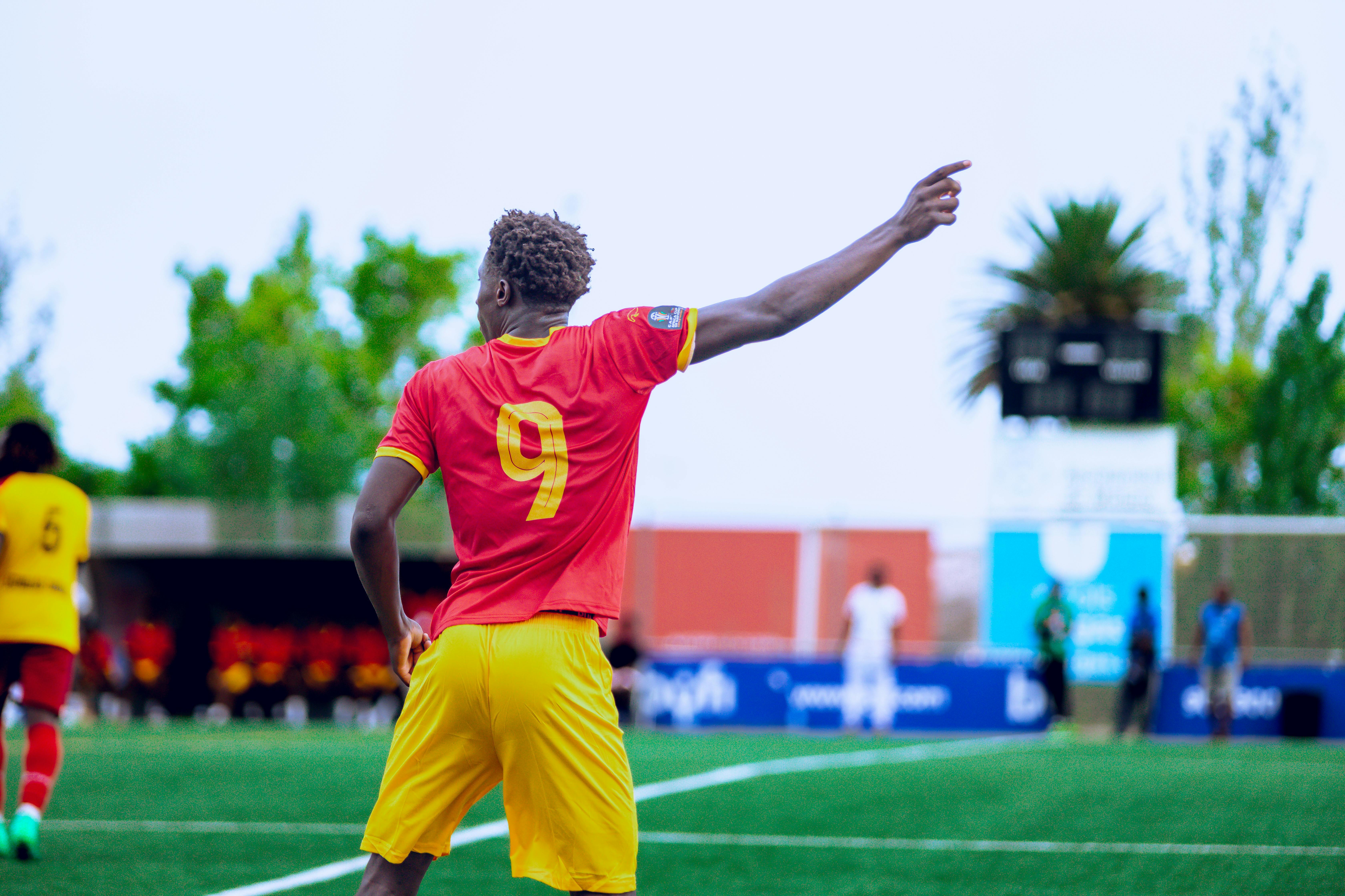 Football Player Pointing on Field During Match · Free Stock Photo