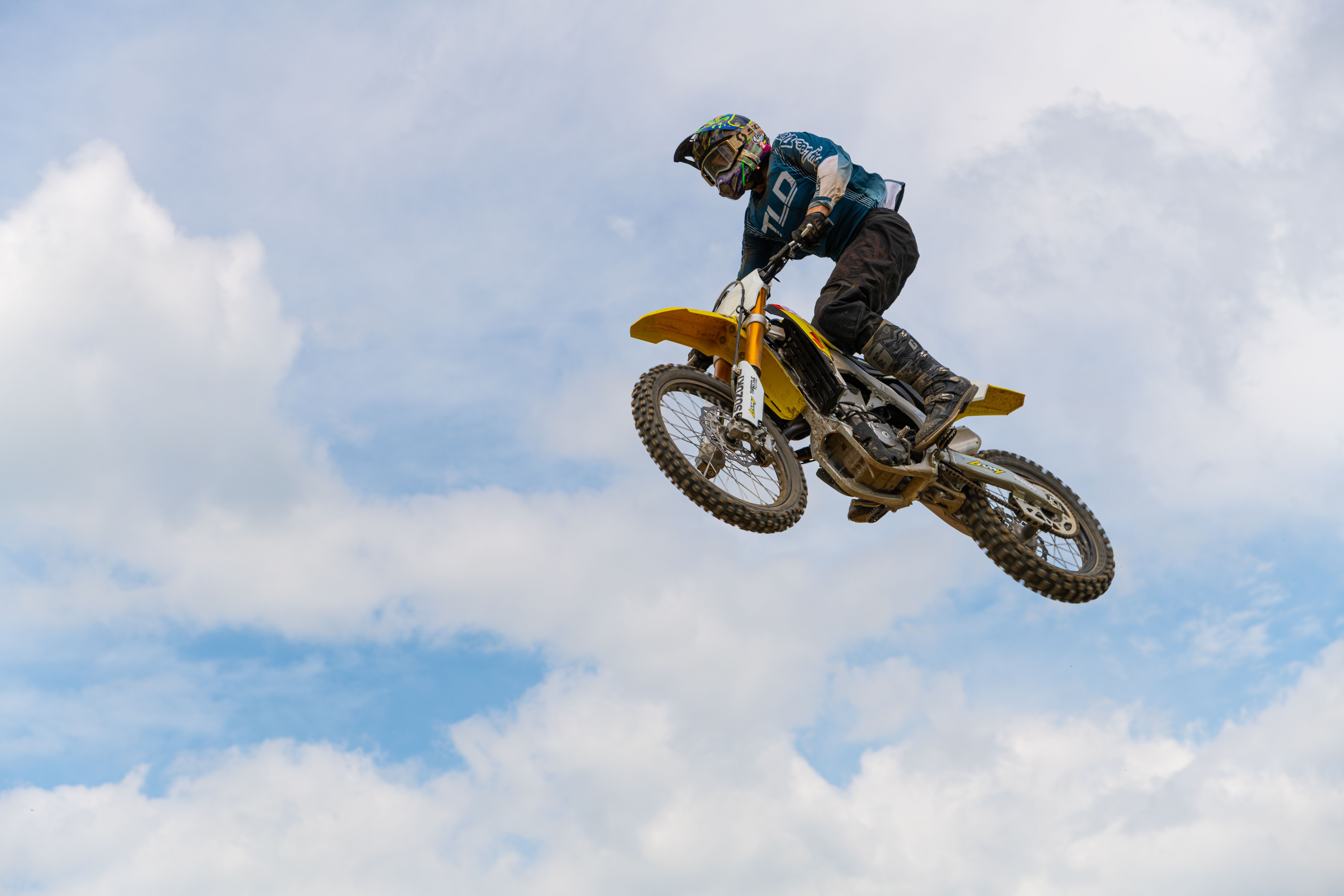 Dynamic Dirt Bike Jump in Clear Blue Sky · Free Stock Photo
