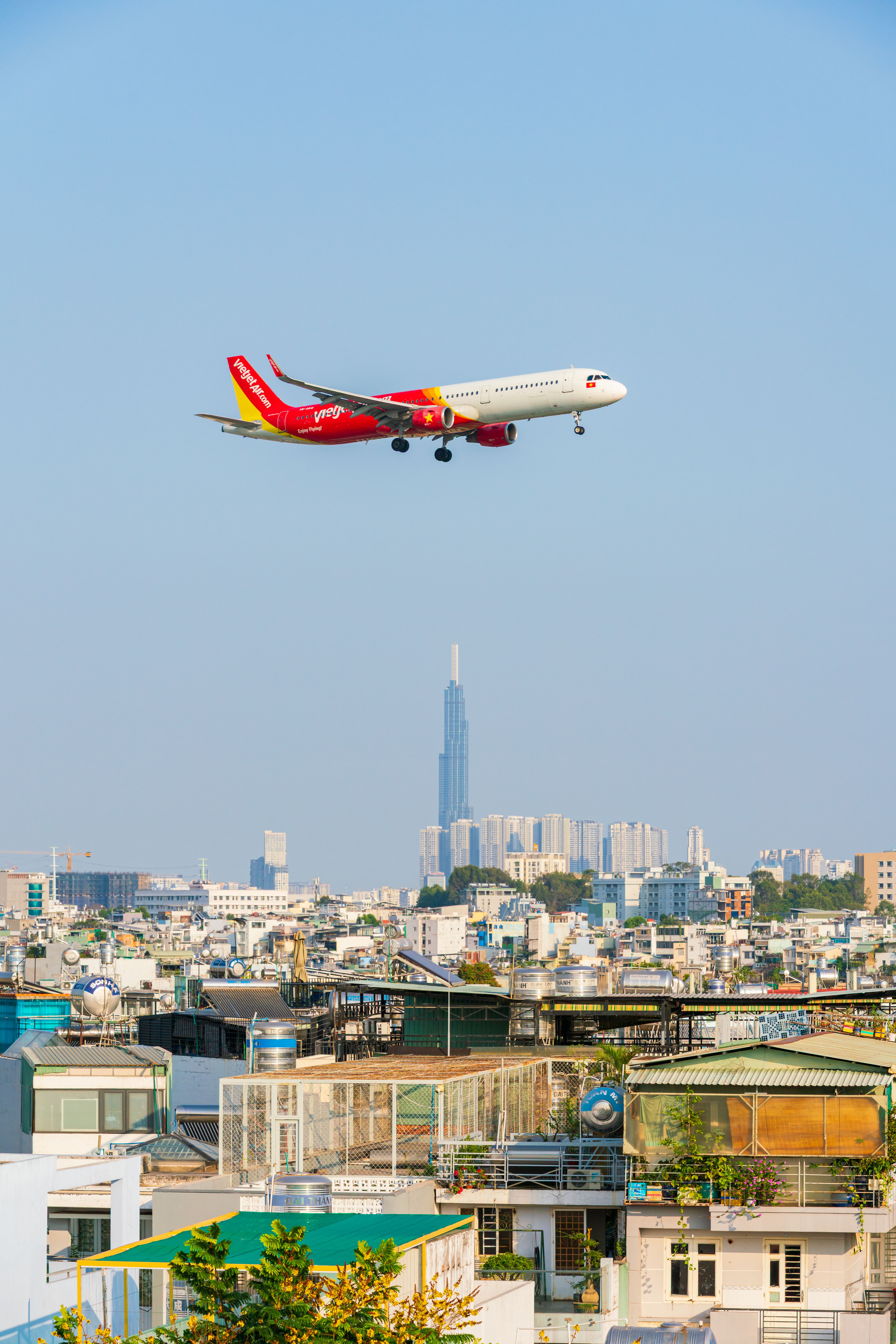 Airplane Landing Over Ho Chi Minh City Skyline · Free Stock Photo