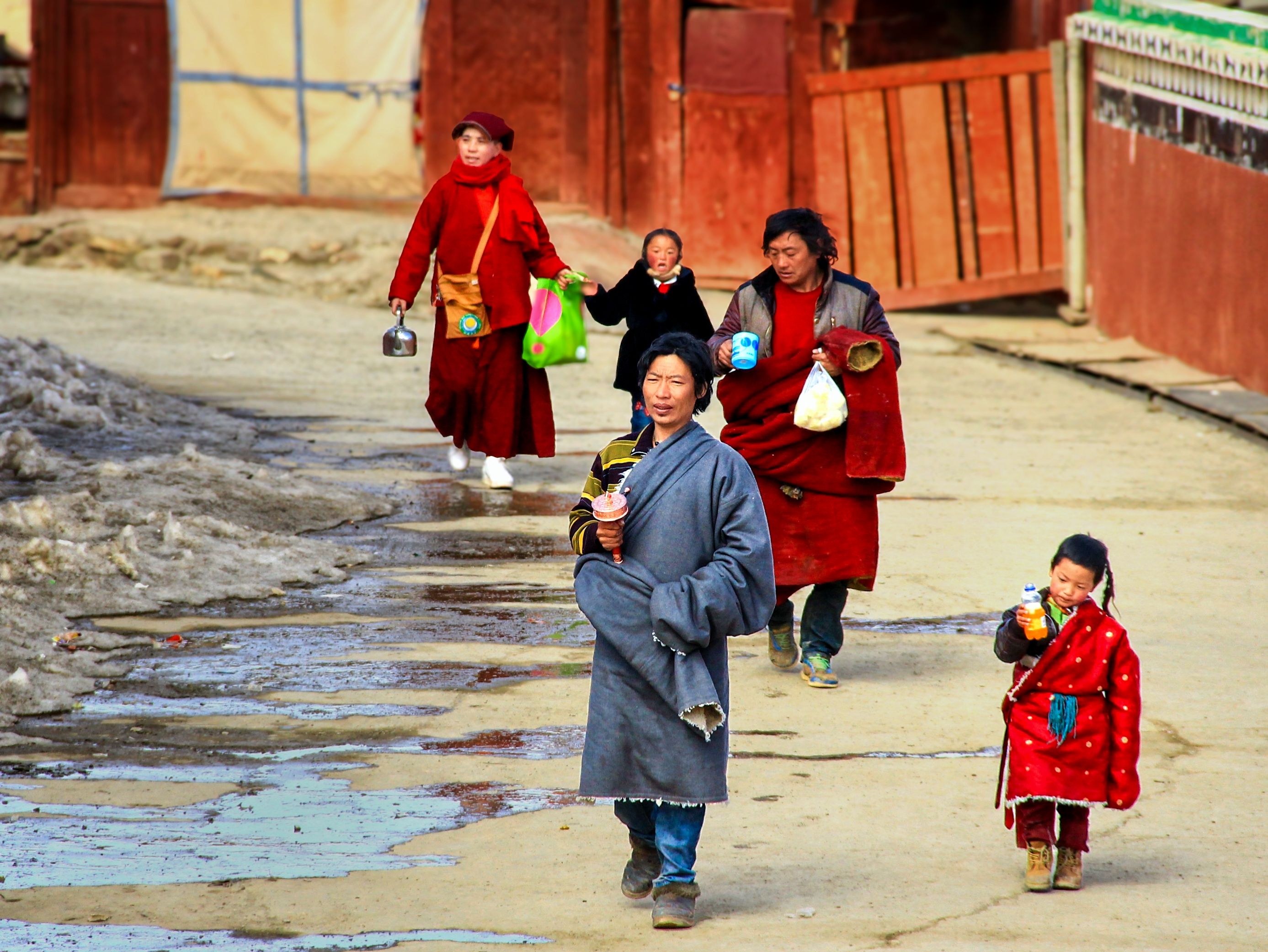 Tibetan Family in Traditional Attire Walking Outdoors · Free Stock Photo
