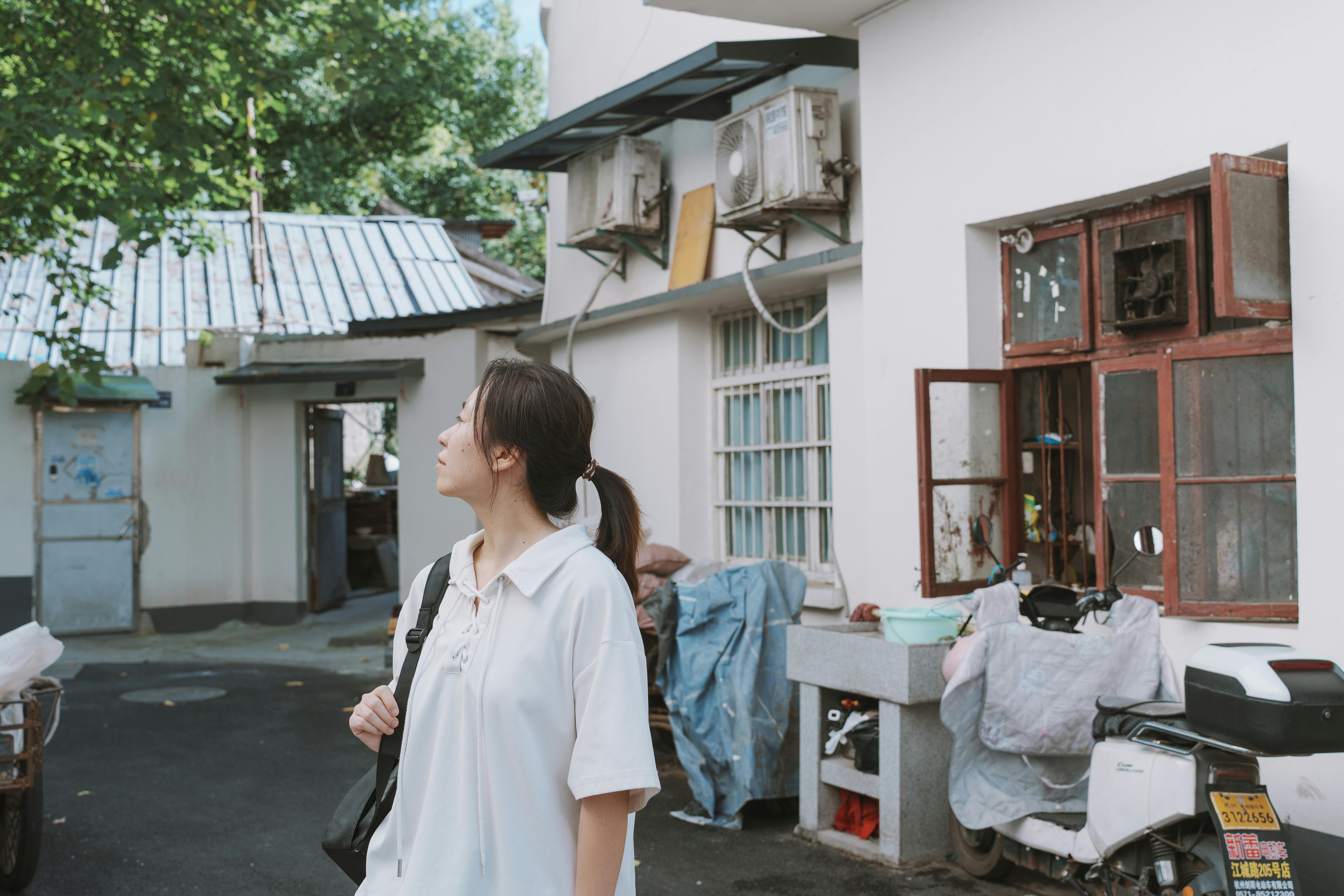 Young Woman in Urban Alleyway on a Summer Day · Free Stock Photo