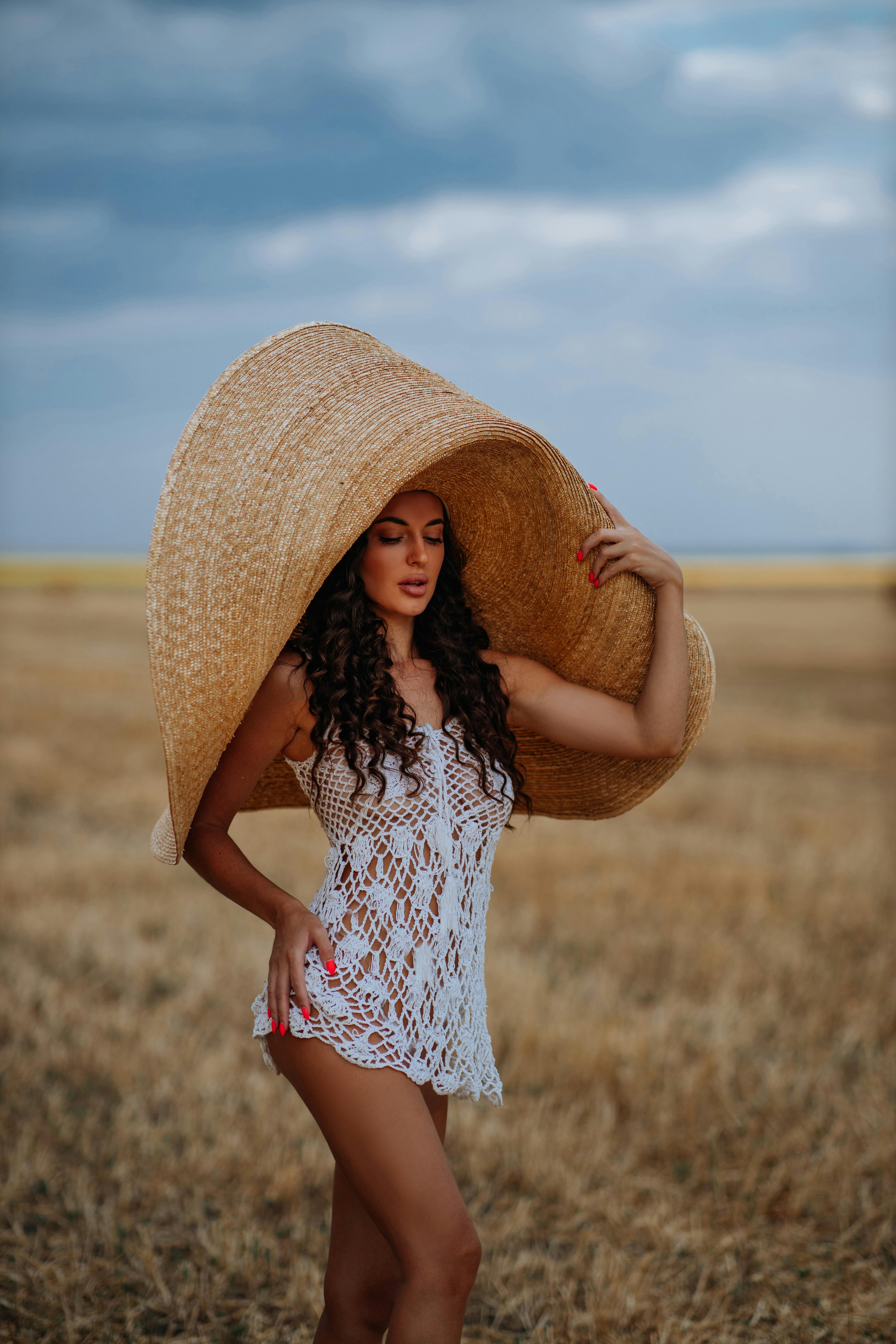 Stylish Woman in Straw Hat Posing in Wheat Field · Free Stock Photo