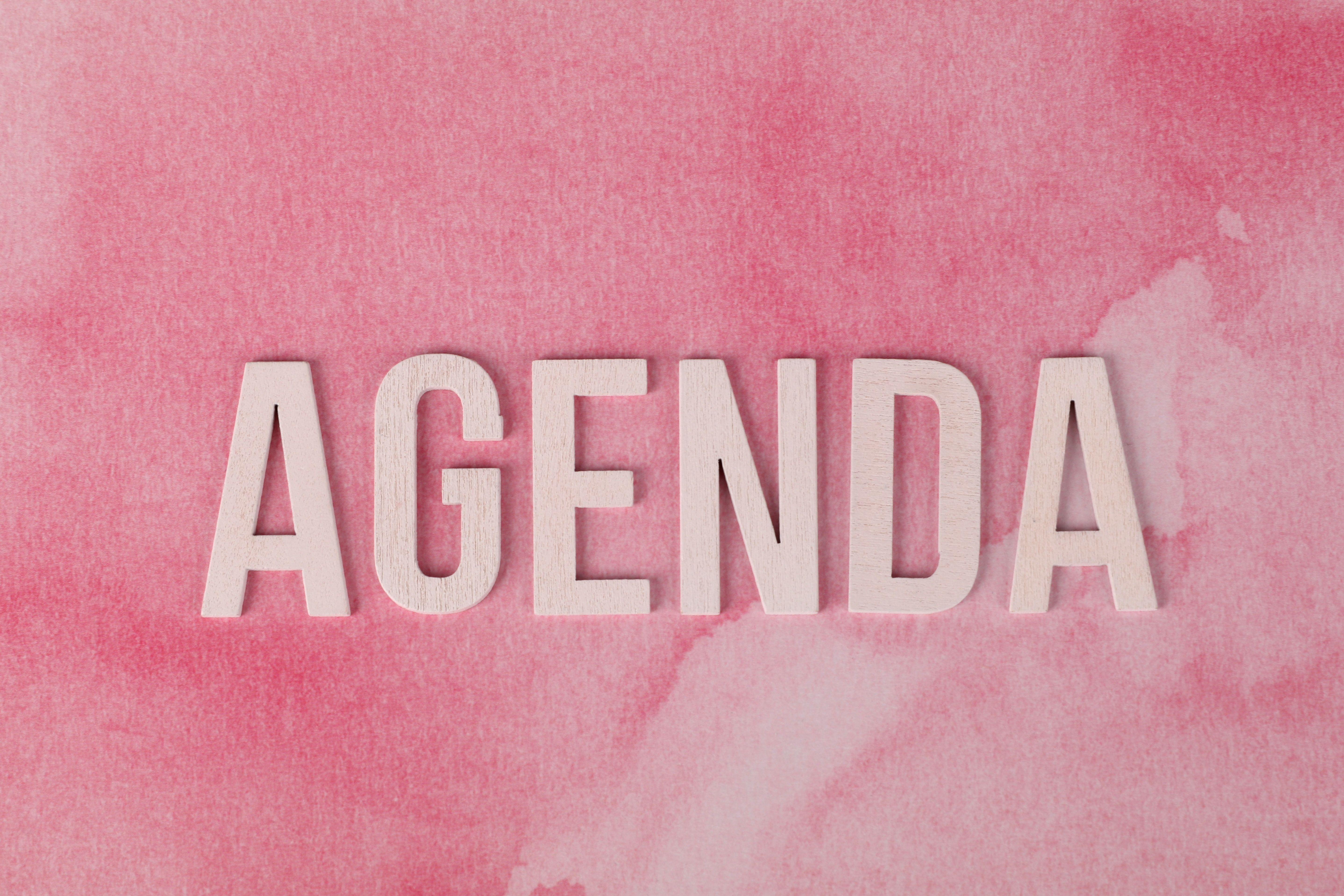 Pink Background with the Word Agenda in Bold Text · Free Stock Photo