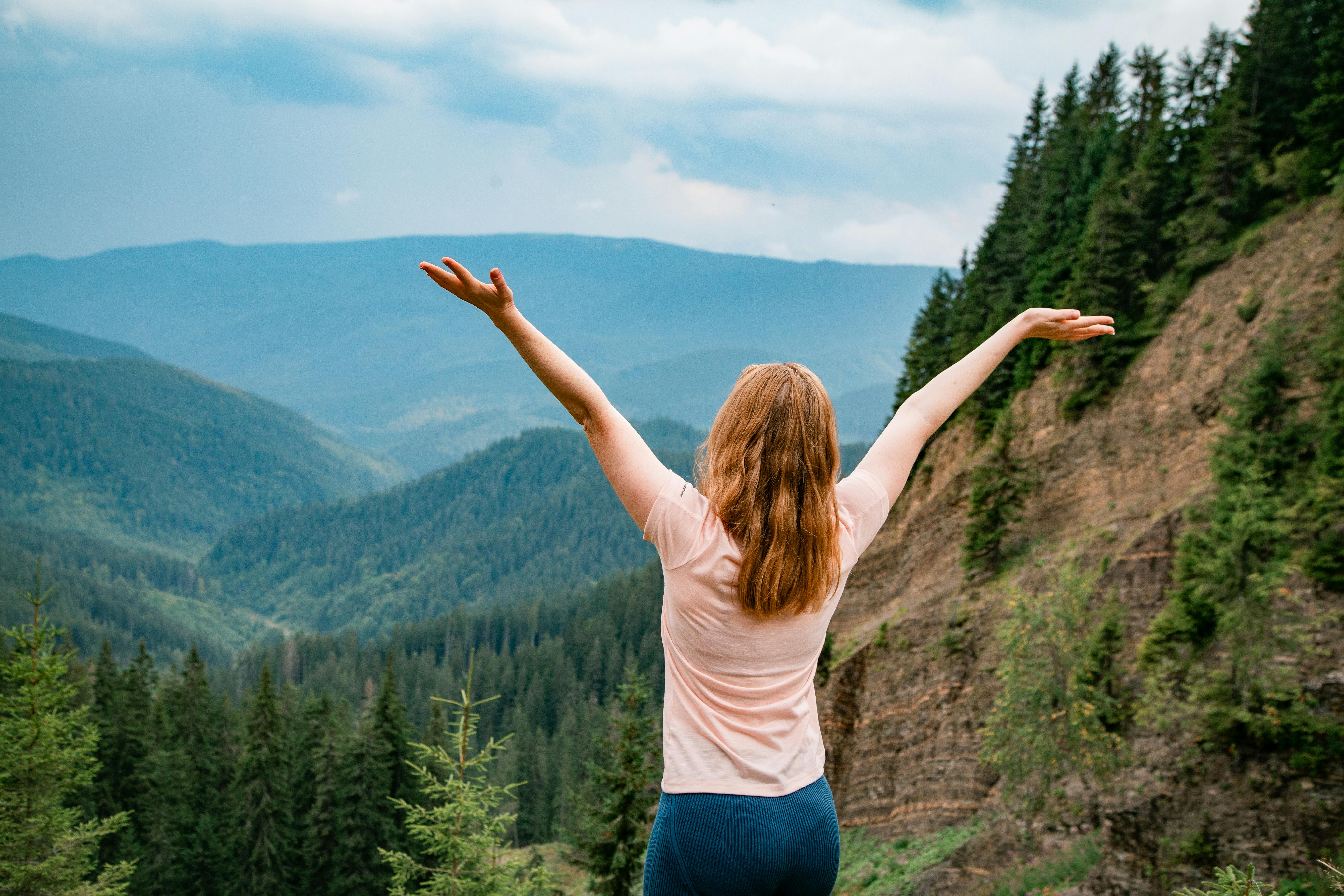 Joyful Woman Embracing Mountain Landscape · Free Stock Photo
