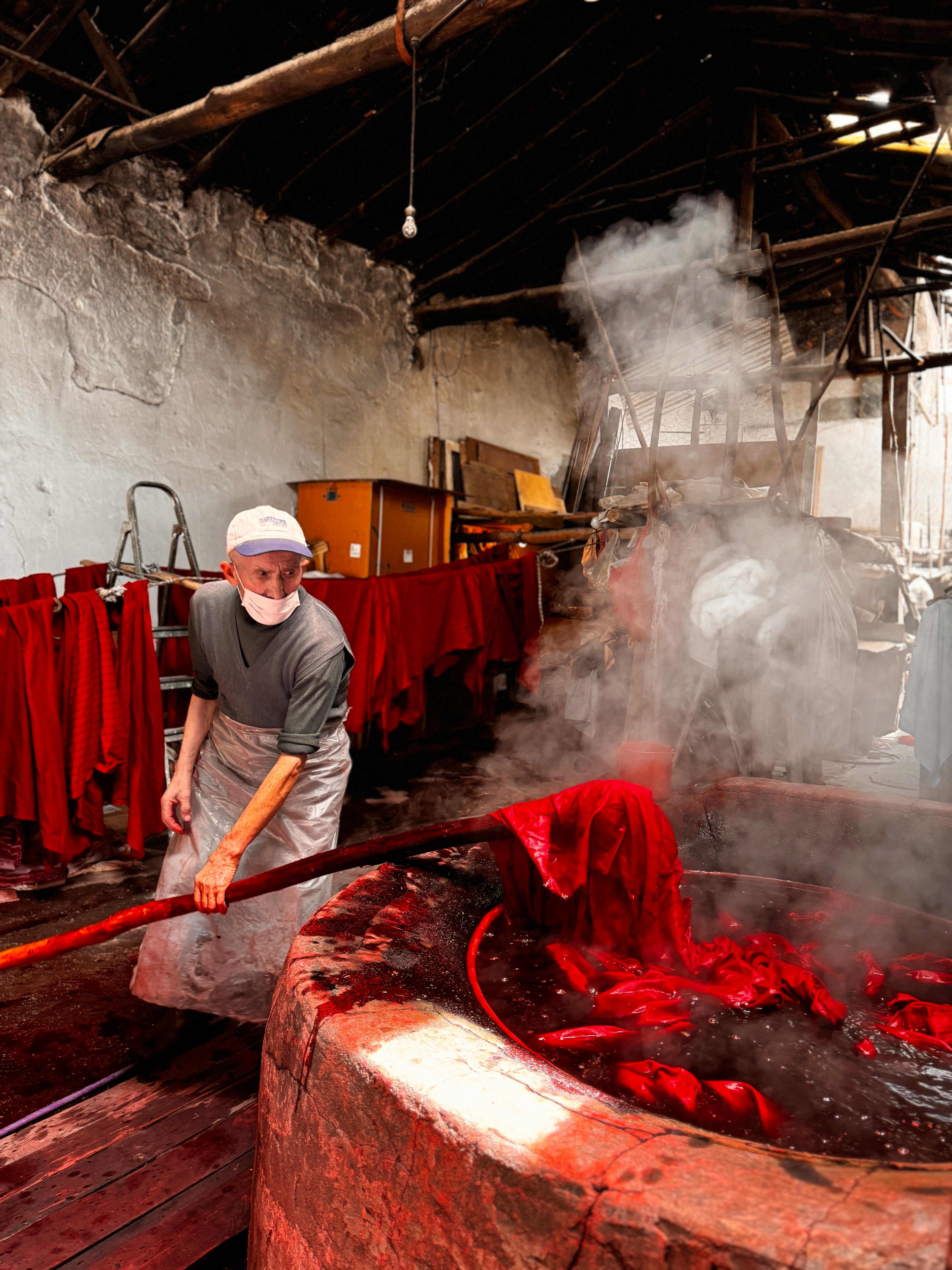 Traditional Textile Dyeing Workshop with Red Fabrics · Free Stock Photo