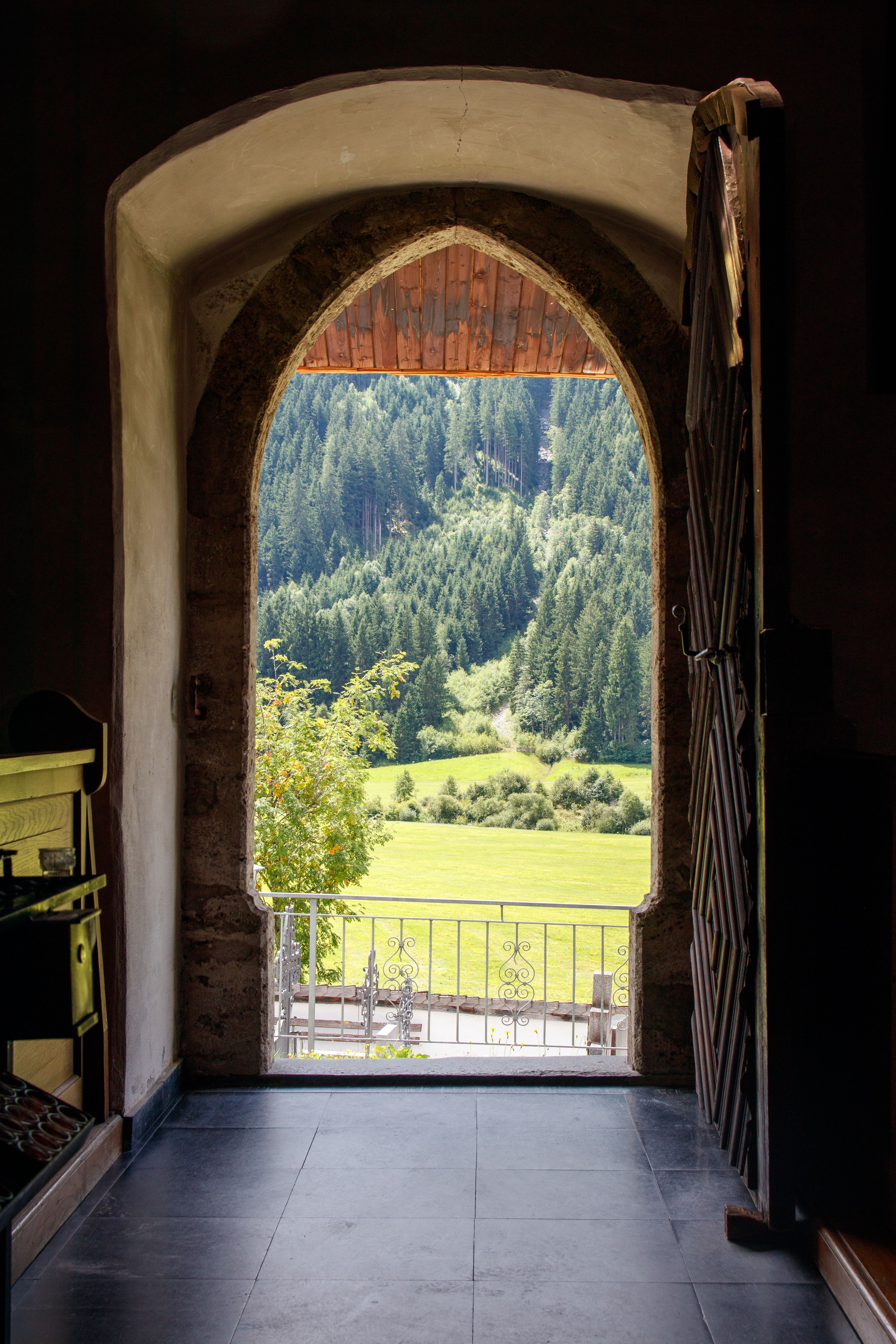Picturesque View Through Rustic Arched Doorway · Free Stock Photo